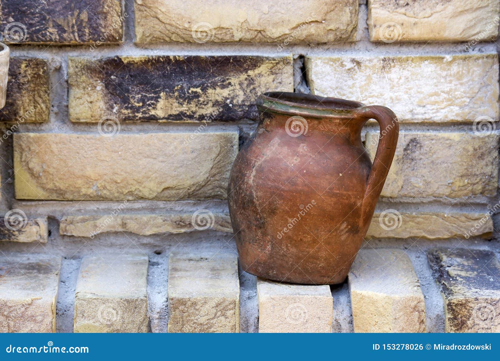Clay pot on a brick wall stock photo. Image of culture - 153278026