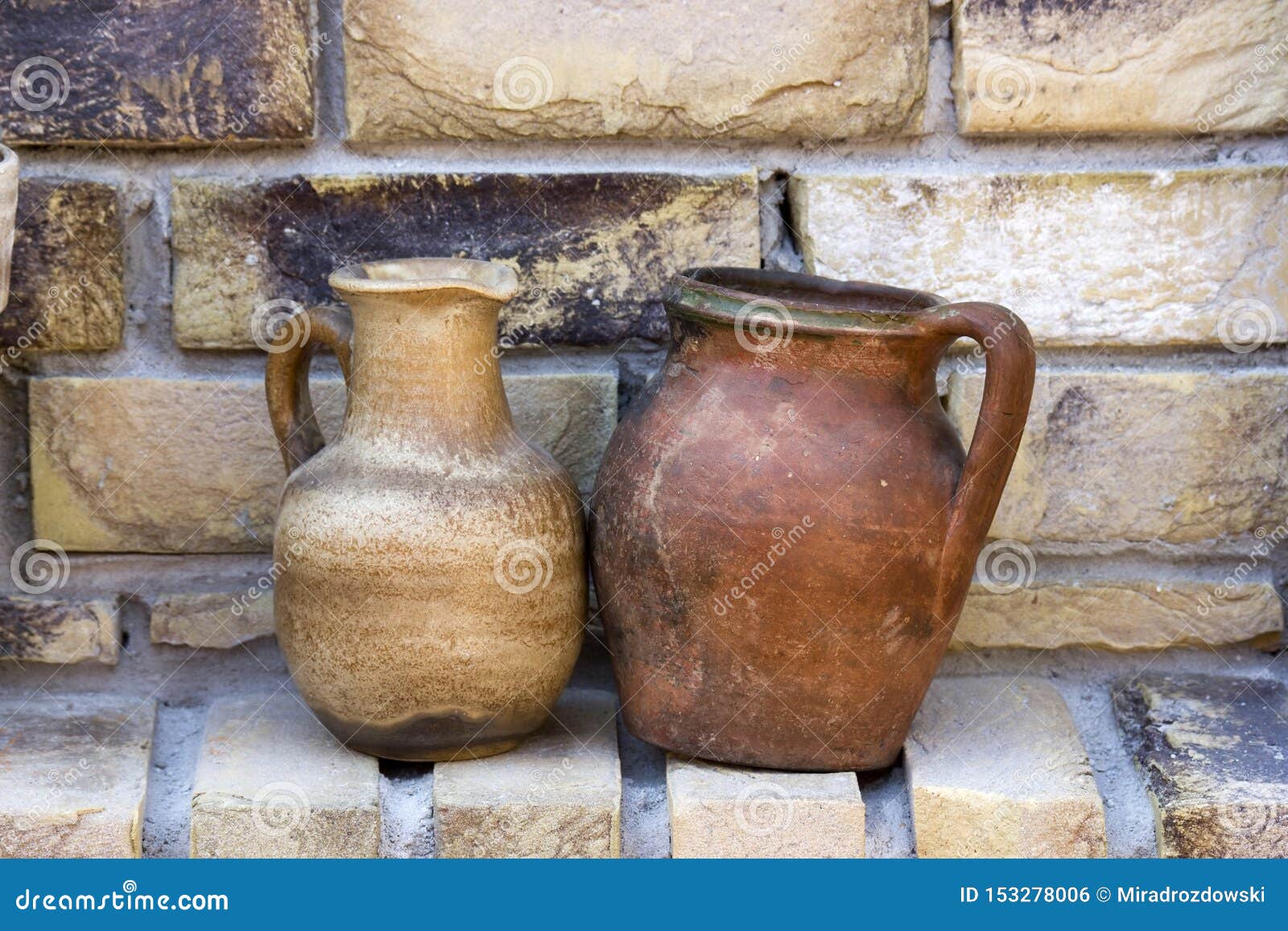 Clay pots on a brick wall stock photo. Image of beautiful - 153278006