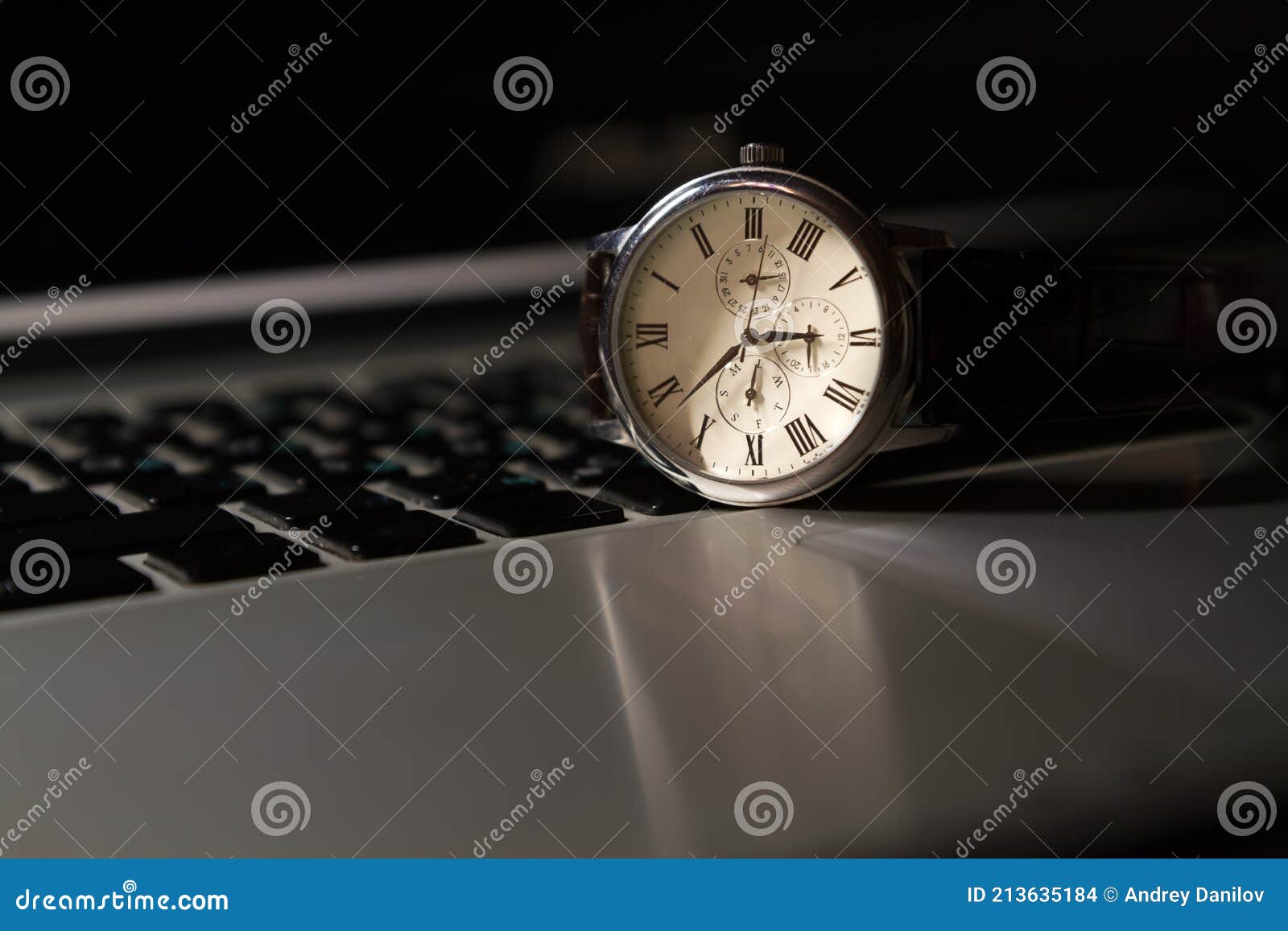 An Old Clock and a Laptop , the Clock is on the Laptop Keyboard. Watch ...