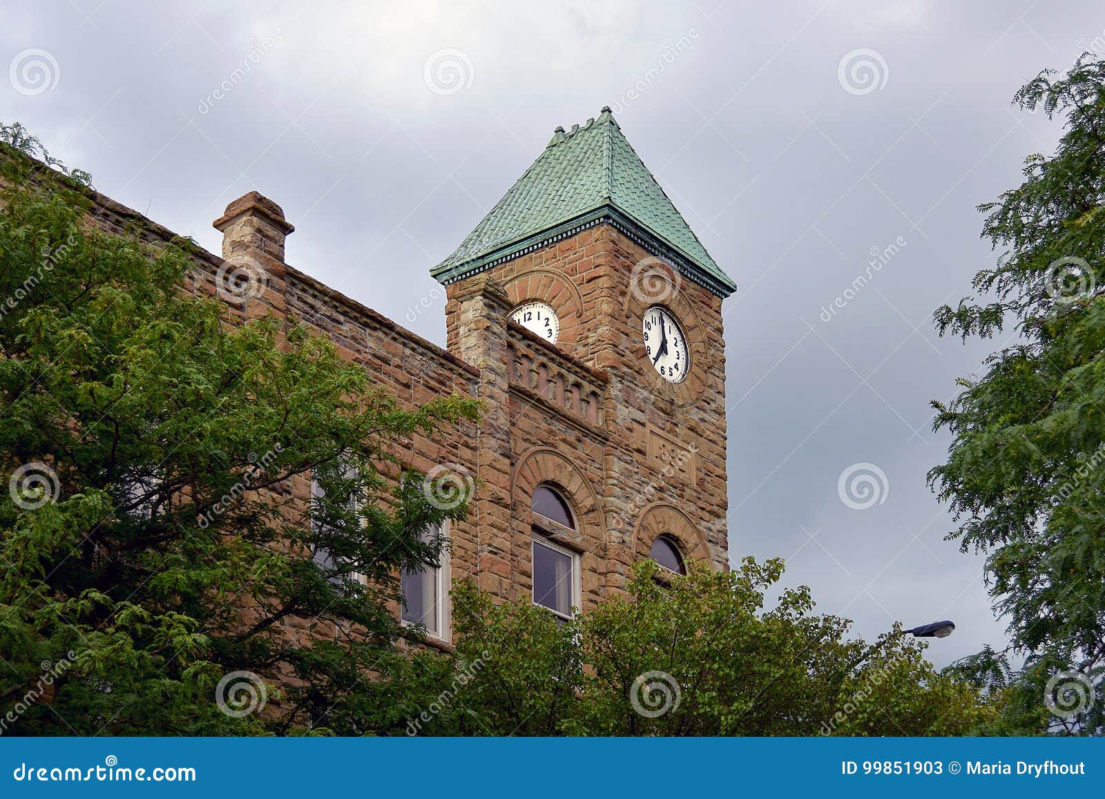 Old clock tower in trees stock image. Image of clock - 99851903