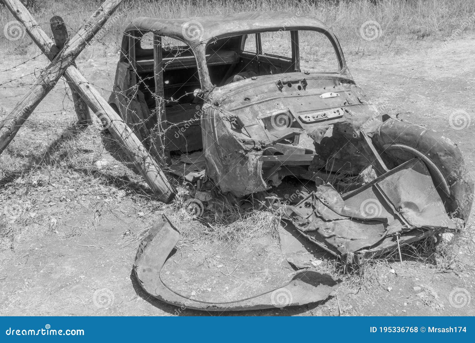 Old Collapsed Retro Car Thrown on a Rusty Field after the War. Stock ...