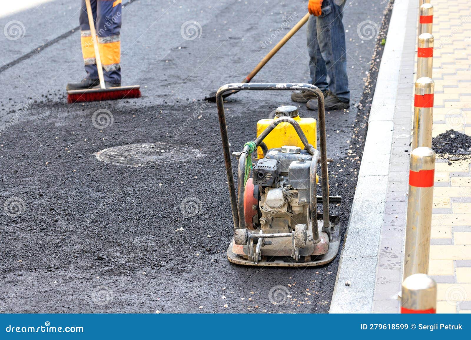 An Old Compacting Vibrating Plate Stands at the Curb Against the ...