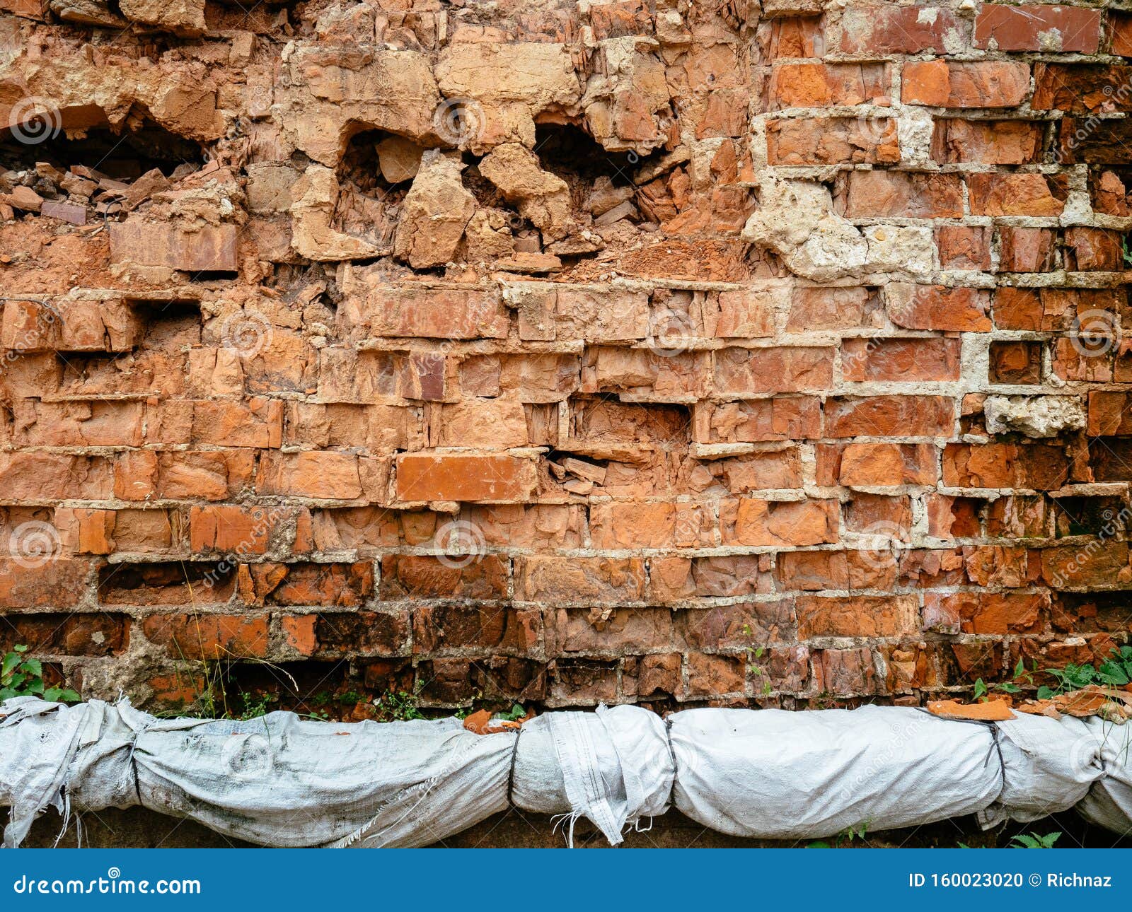 An Old, Crumbling Brick Wall and a Heating Main Passing by Stock Photo ...