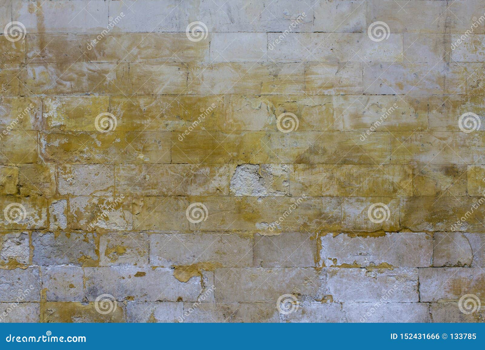 Old Damaged Gray Wall Of Large Bricks With Yellow Spots Of Paint. Rough ...