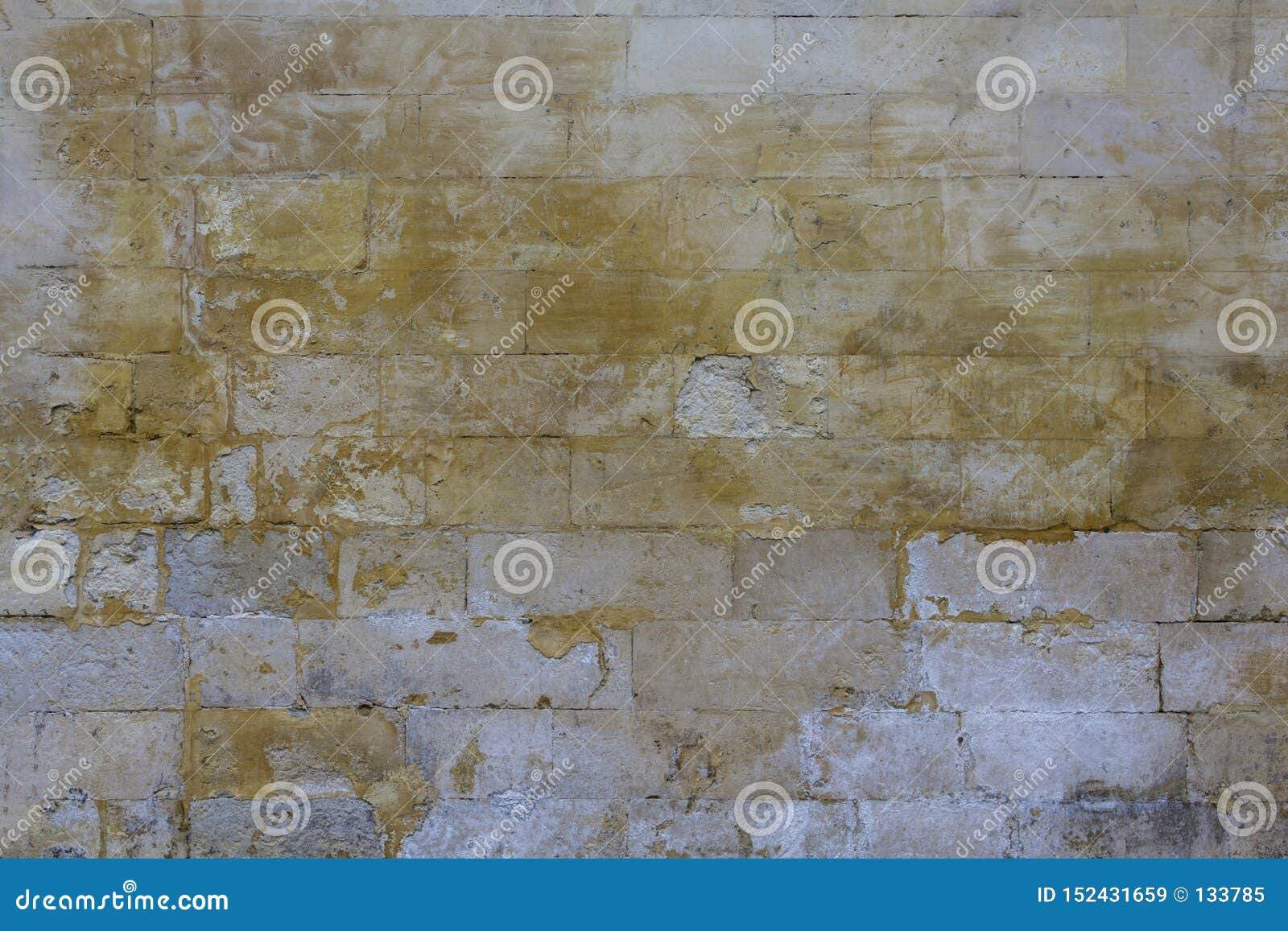Old Damaged Gray Wall Of Large Bricks With Yellow Spots Of Paint. Rough ...