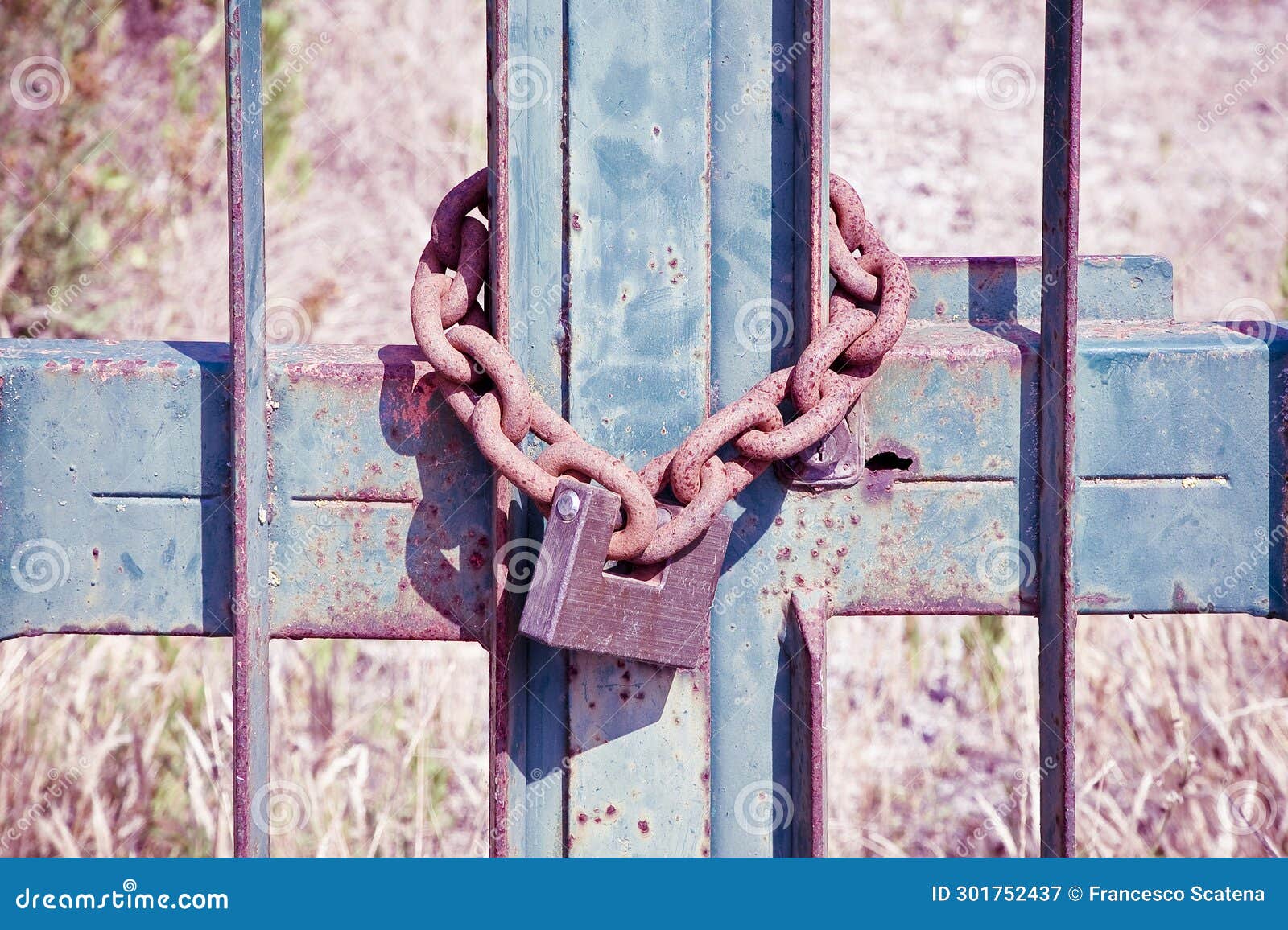 Old Damaged and Rusty Metal Gate of a Factory Closed with Padlock ...