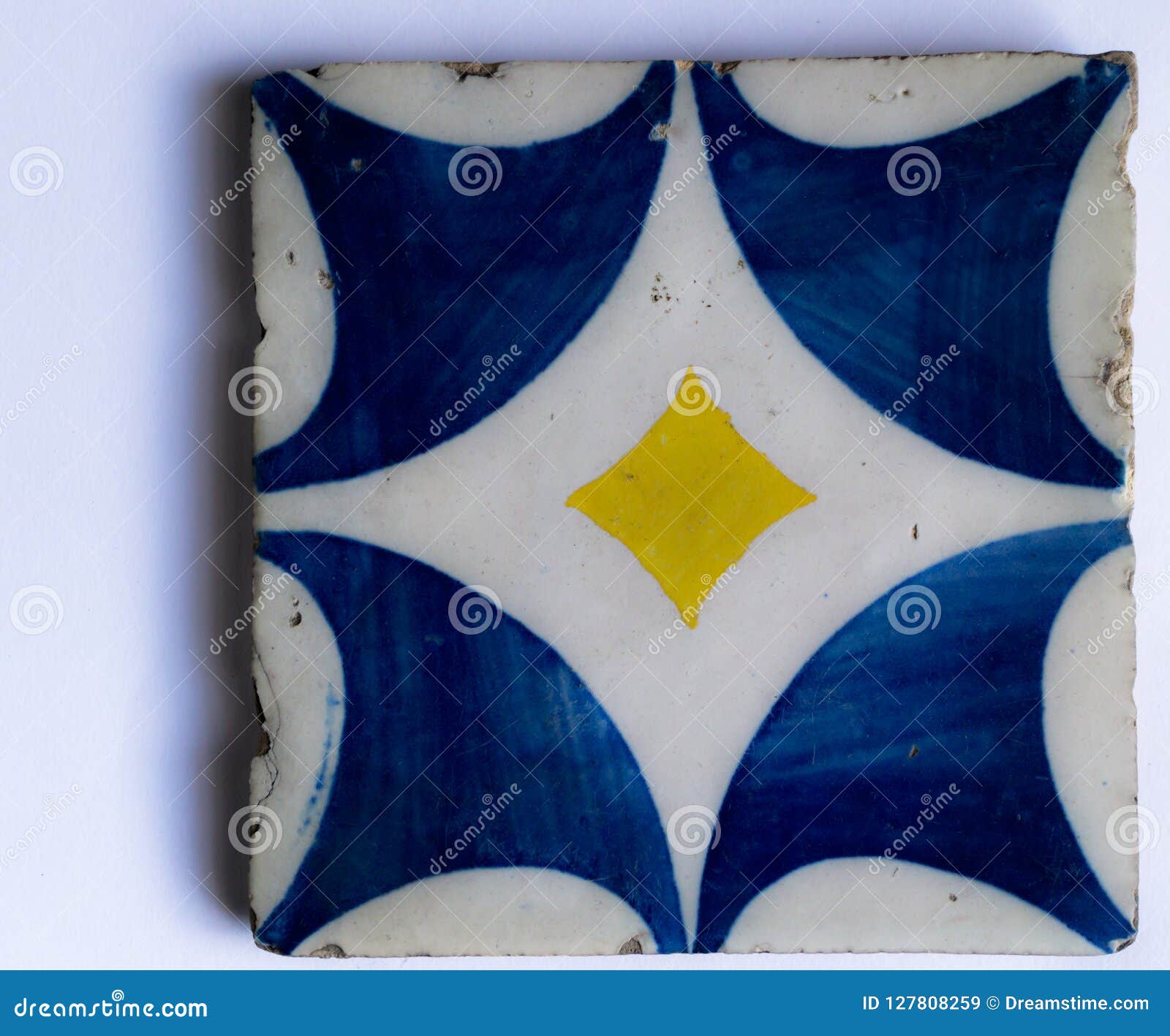 Old Decorative Tile Showing a Blue and Yellow Pattern Stock Image ...