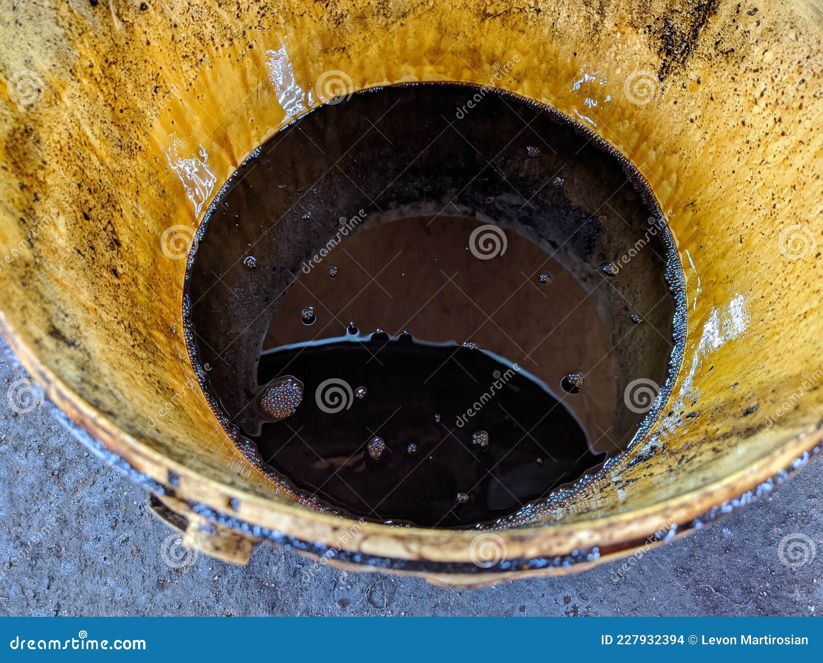 Old Dirty Bucket with Used Engine Oil in the Garage. Stock Photo ...
