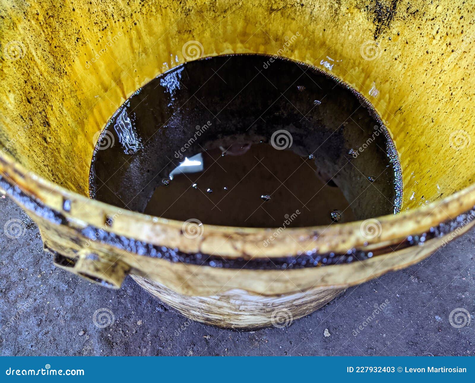 Old Dirty Bucket with Used Engine Oil in the Garage. Stock Image ...