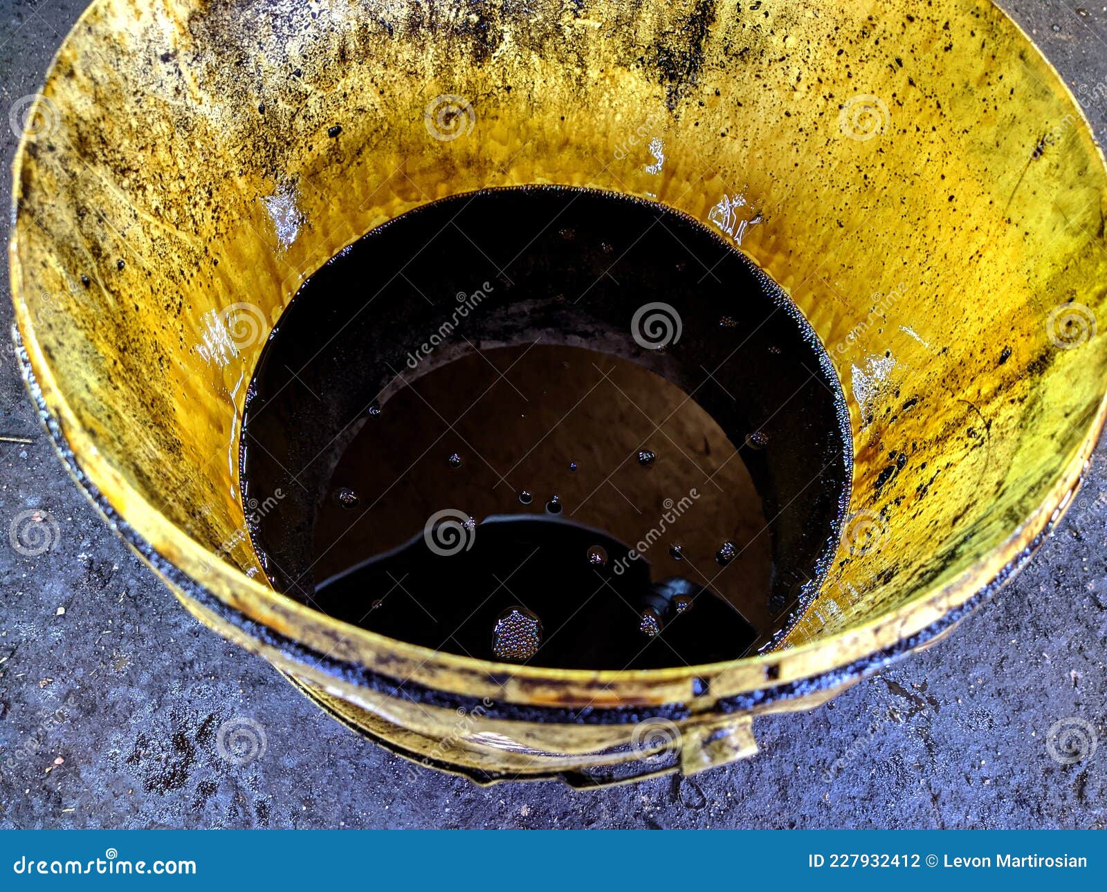 Old Dirty Bucket with Used Engine Oil in the Garage. Stock Photo ...