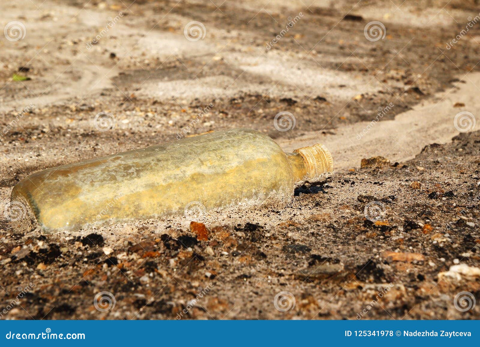Old Dirty Glass Bottle on a Dry Soil. Stock Photo - Image of container ...