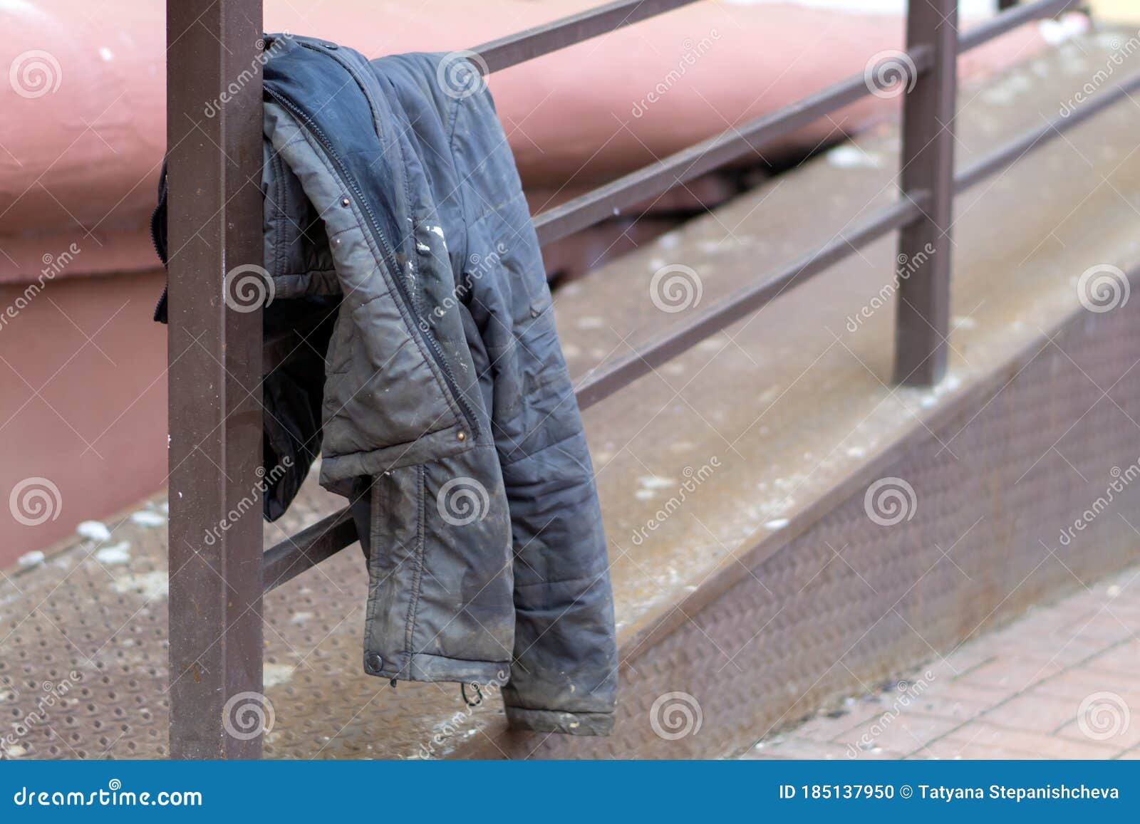 Old Dirty Jacket Hanging on the Railing. Stock Photo - Image of street ...