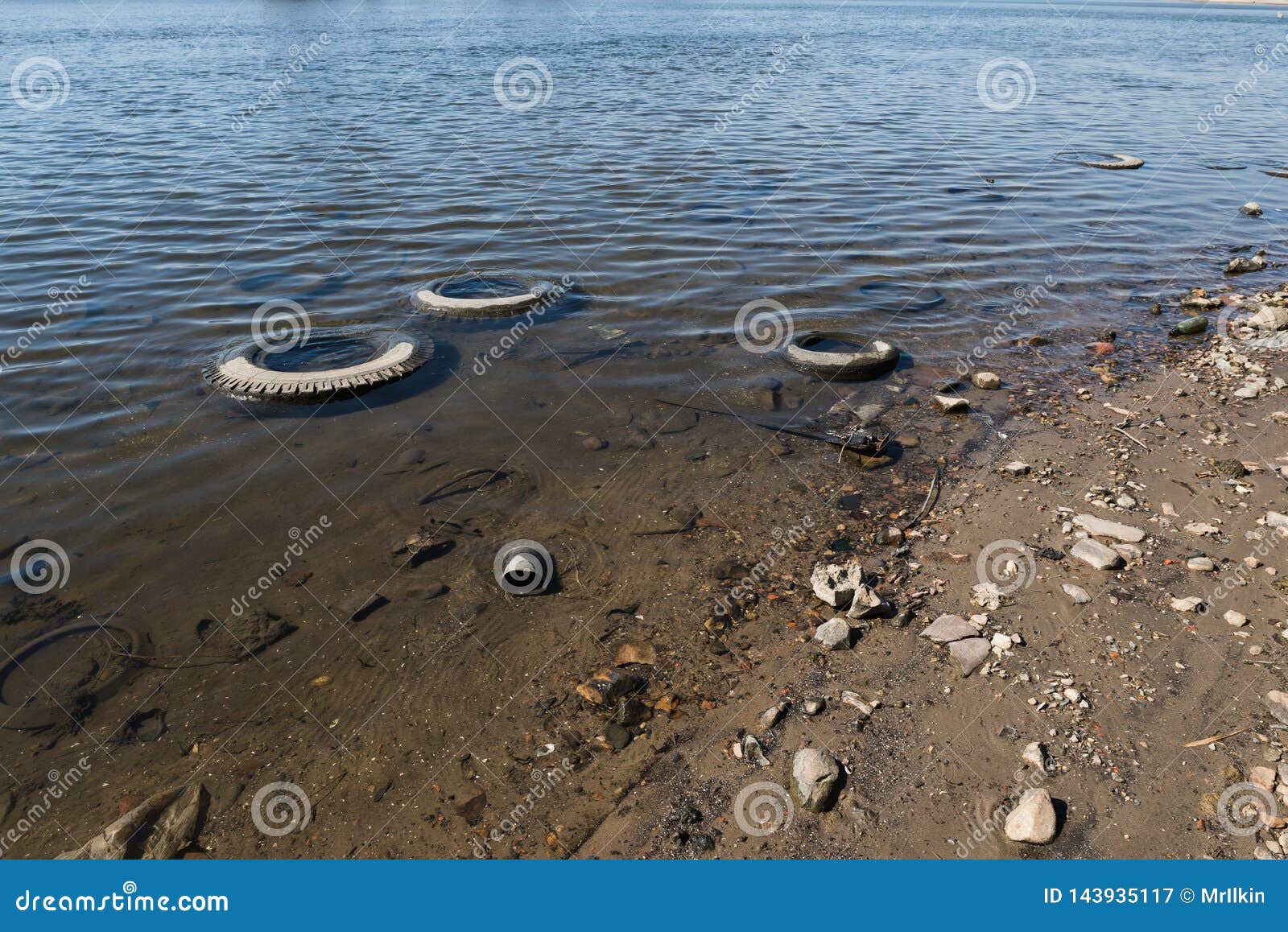 Old Discarded Car Tire Lying on the Sandy Bank of the River. Stock ...