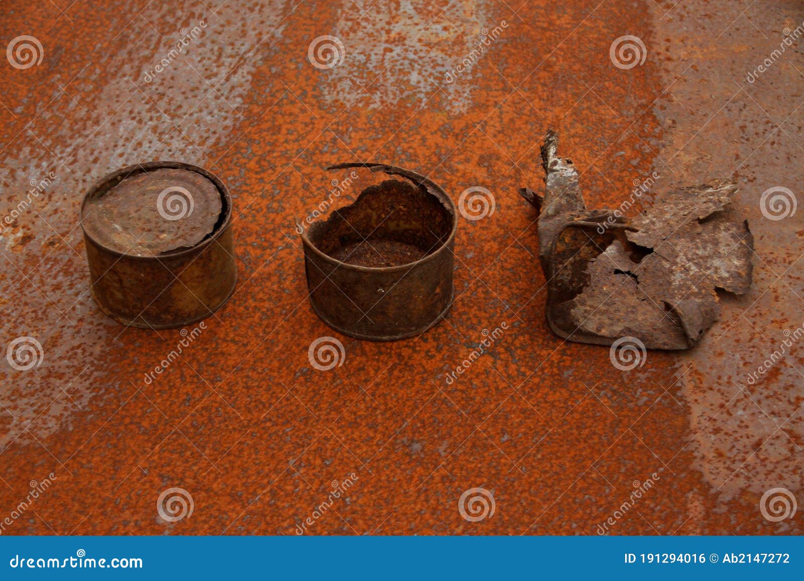 Old Discarded Rusty Cans on a Metal Surface. Decomposition Process ...