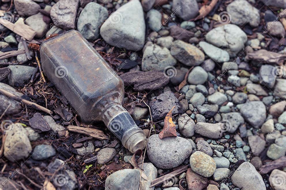Old Discarded Whiskey Bottle on the Ground. Stock Photo - Image of ...