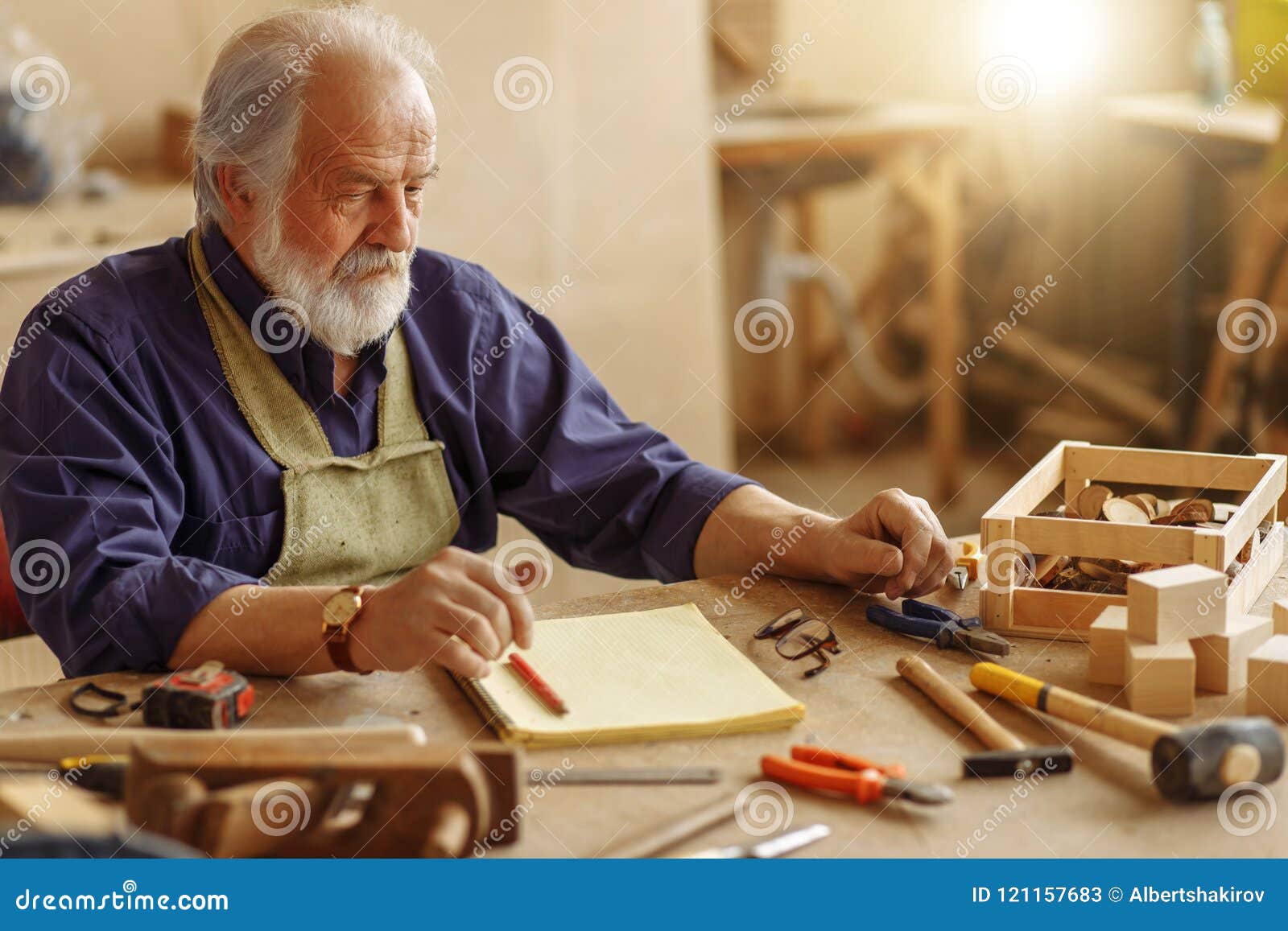 Old Experienced Carpenter Sitting at the Messy Table at Workplace Stock ...