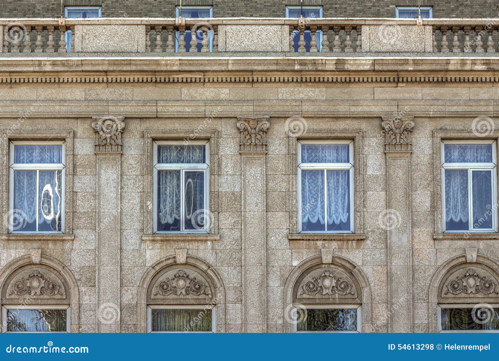 Old Exterior Stone Wall with Row of Windows with Lace Curtains Stock ...