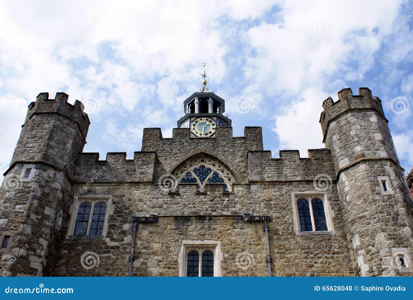 Old Facade With A Clock Tower, Turrets, And Battlements Stock Photo ...
