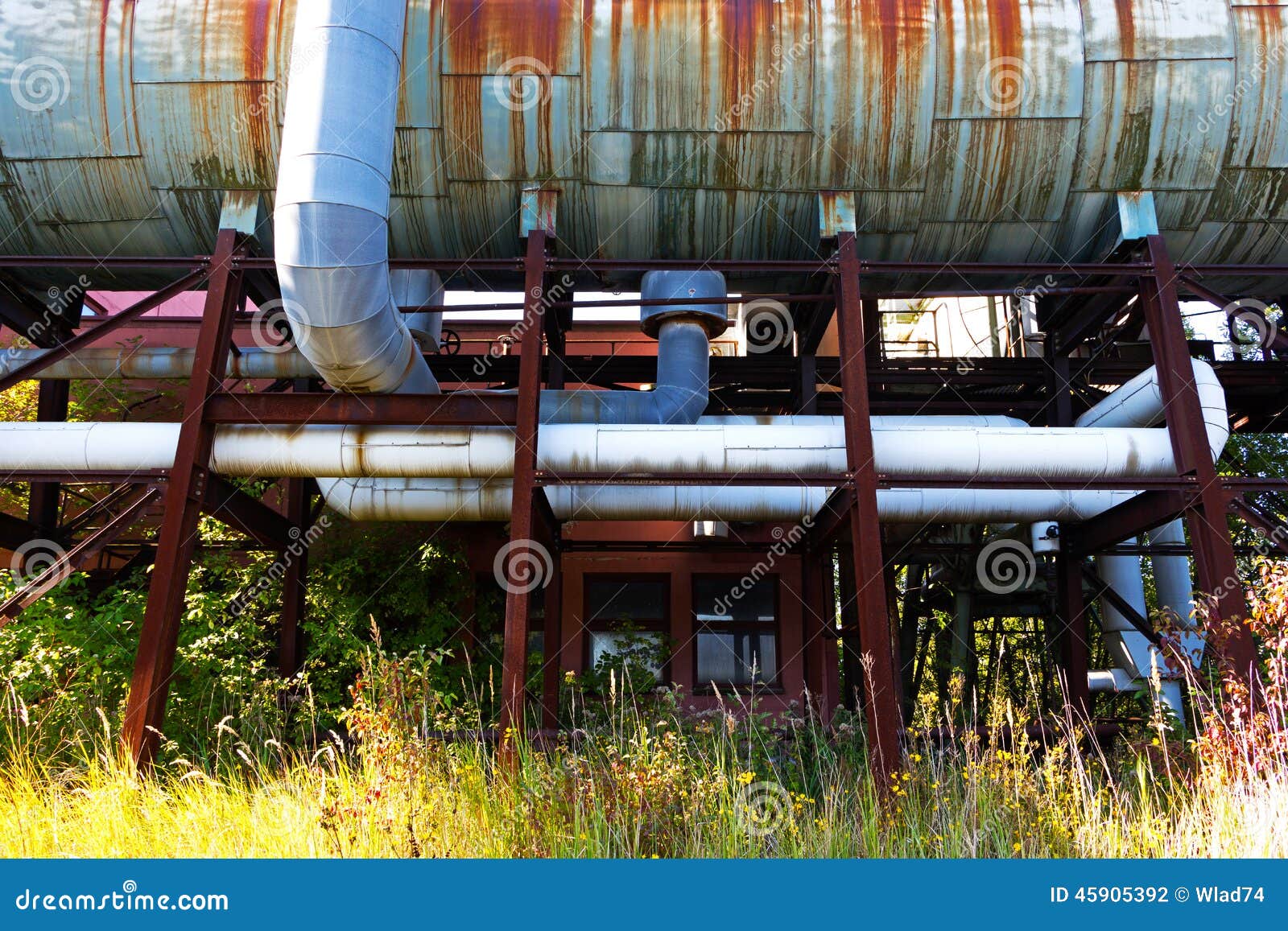Old Factory and Grass in Sunshine Stock Photo - Image of pipe, leaf ...