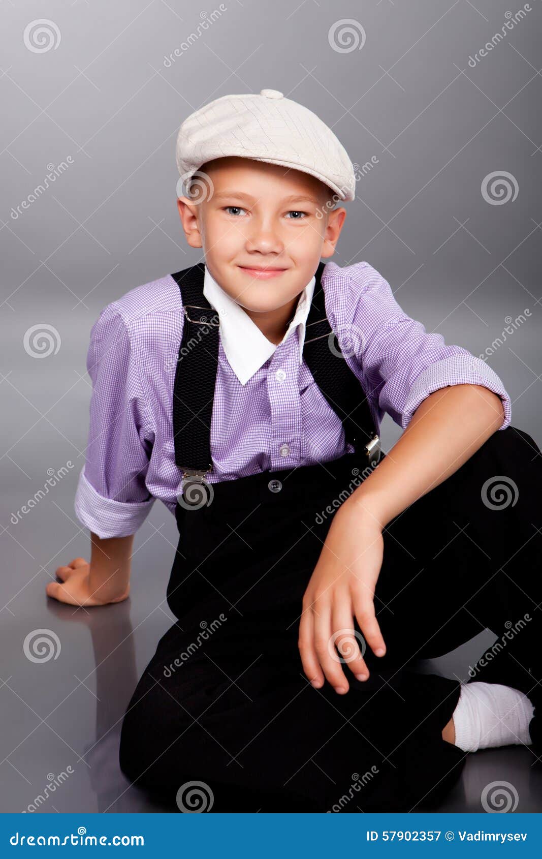 Old Fashioned Boy Sitting on Gray Background Stock Image - Image of ...