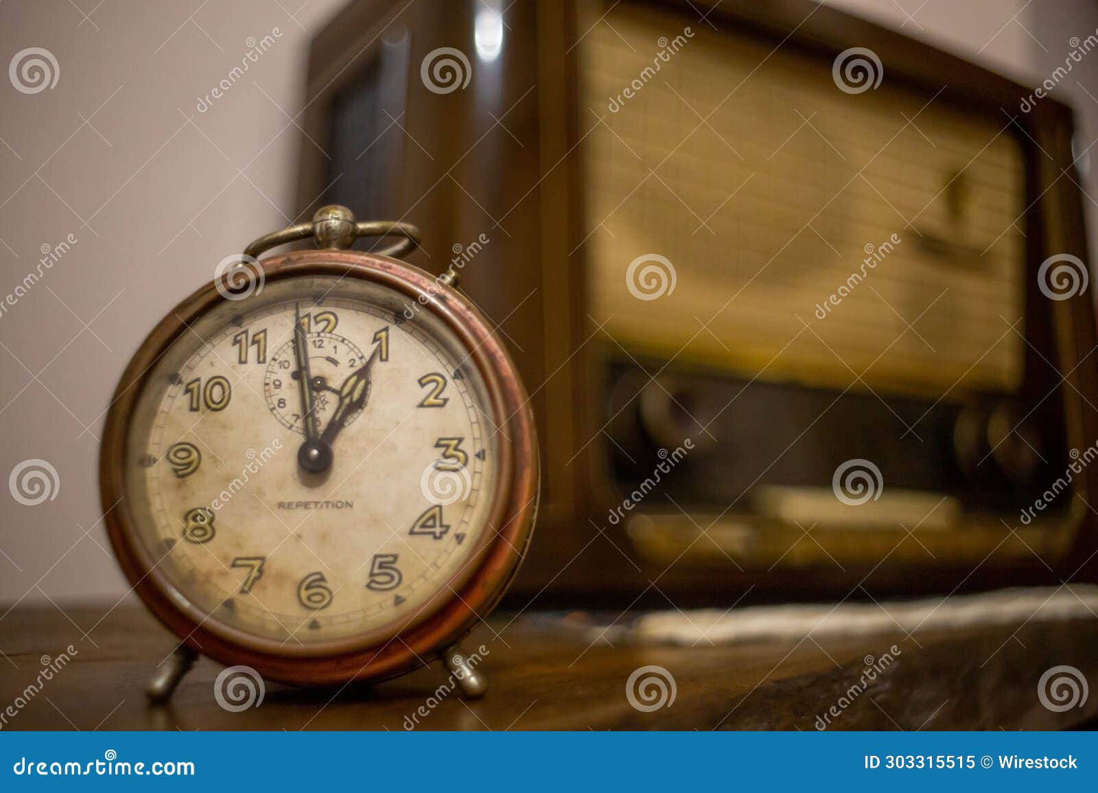 An Old Fashioned Clock Sits on a Shelf in Front of a Television ...