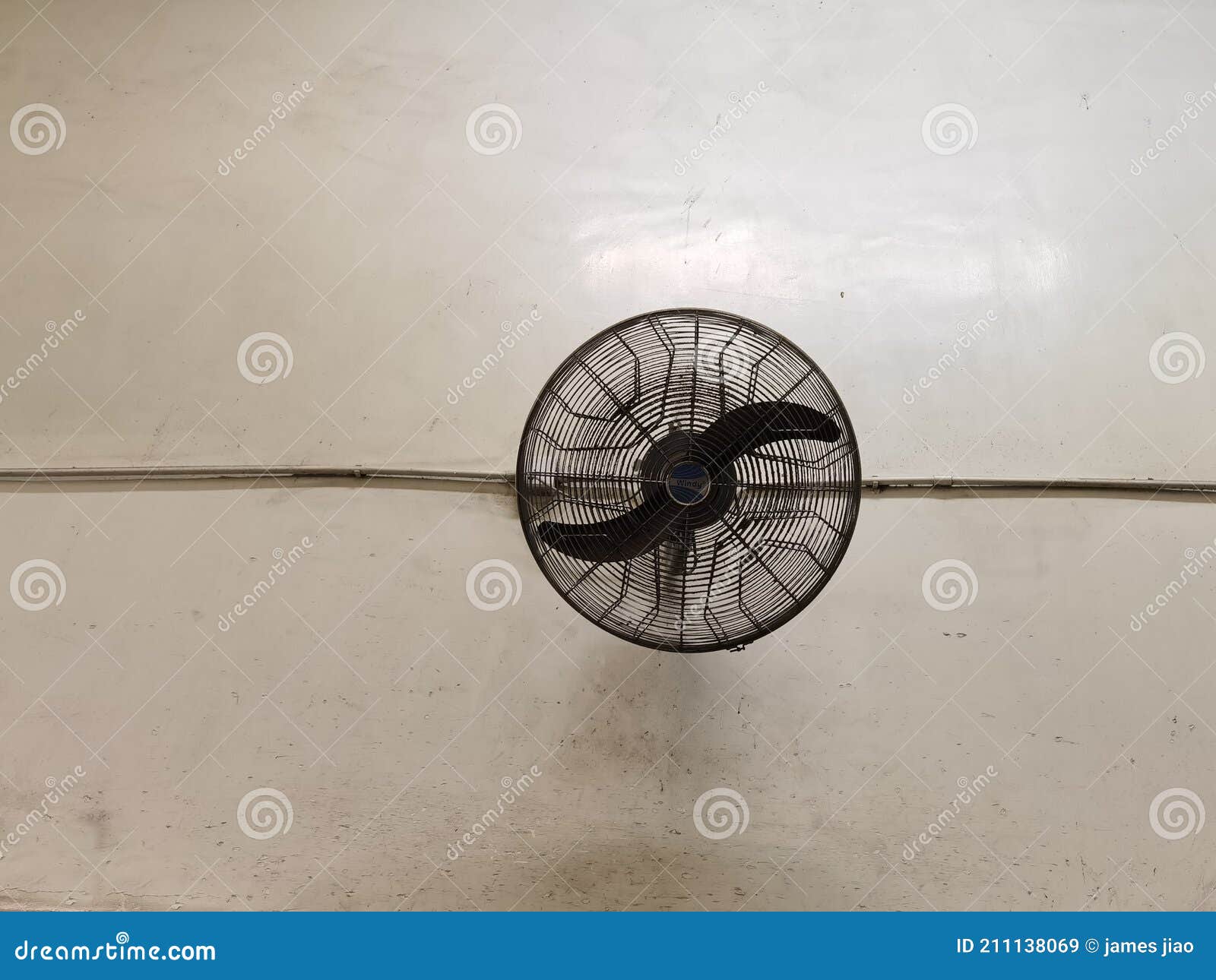 An Old Fashioned Electric Fan Fixed Near the Ceiling To Cold Down Room ...