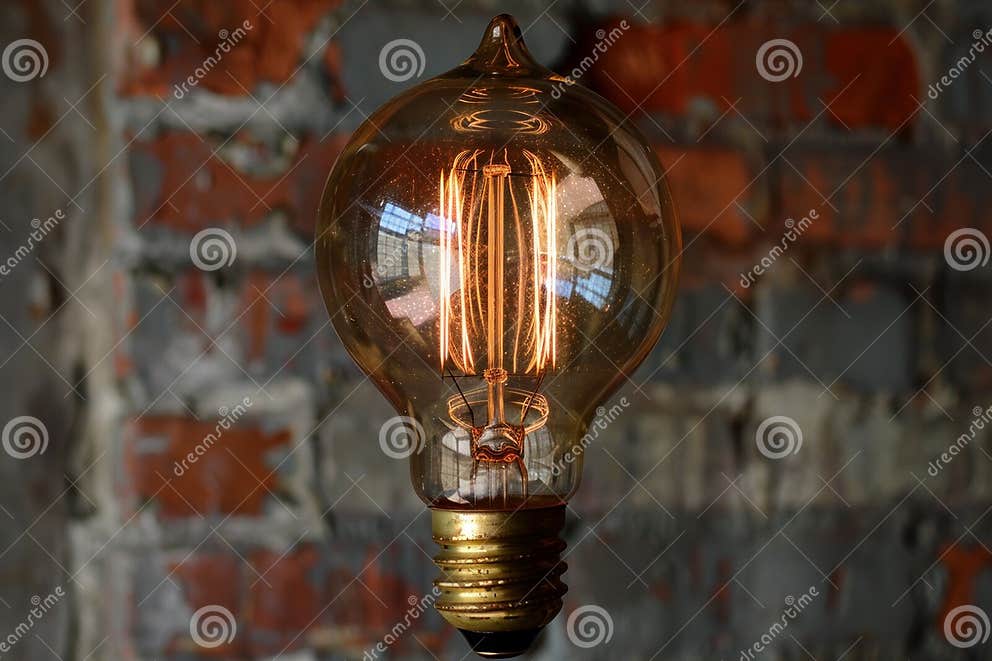 Old Fashioned Light Bulb Glowing in Front of Brick Wall Stock Image ...
