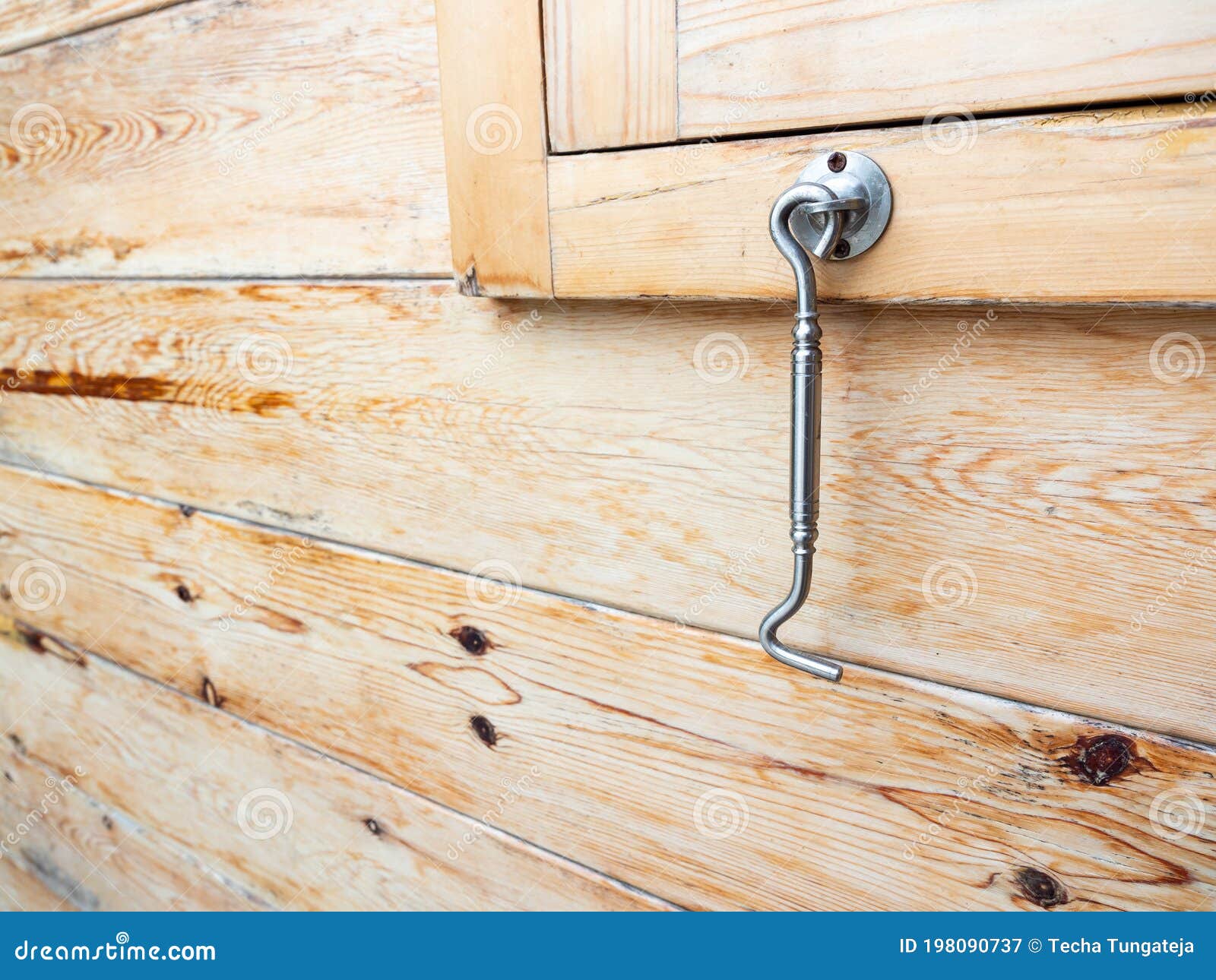Old-fashioned Window Latch Hook Hanging On Wood Wall Background Stock ...