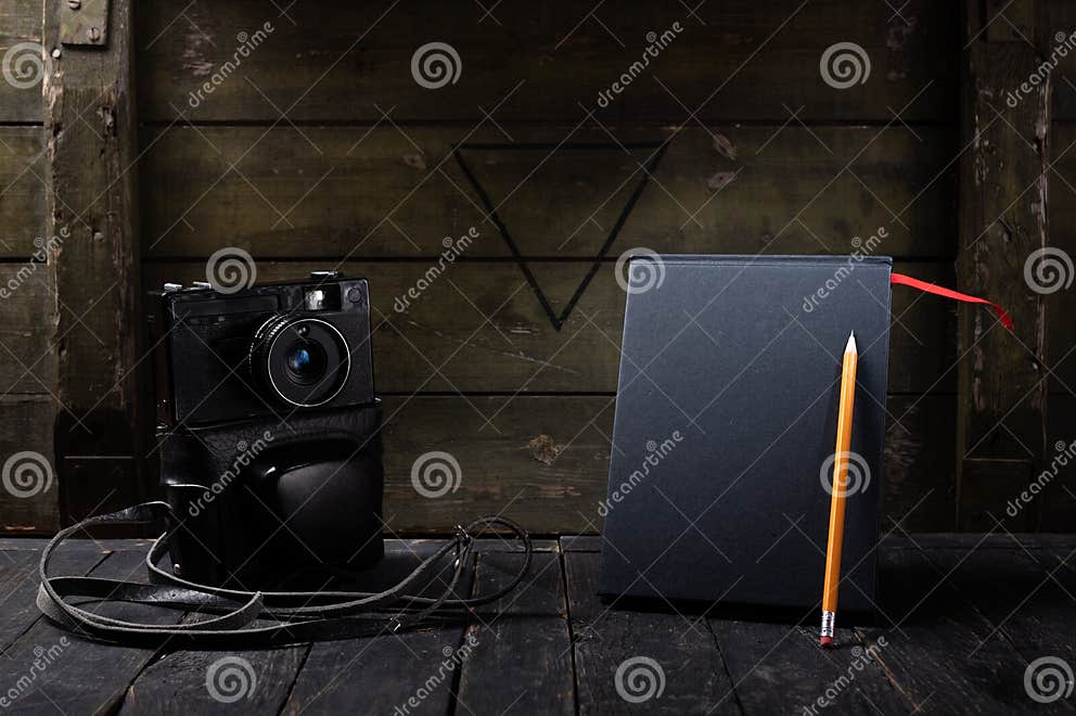 Old Film Camera and Notepad for Writing. Black Camera and Black Notepad ...