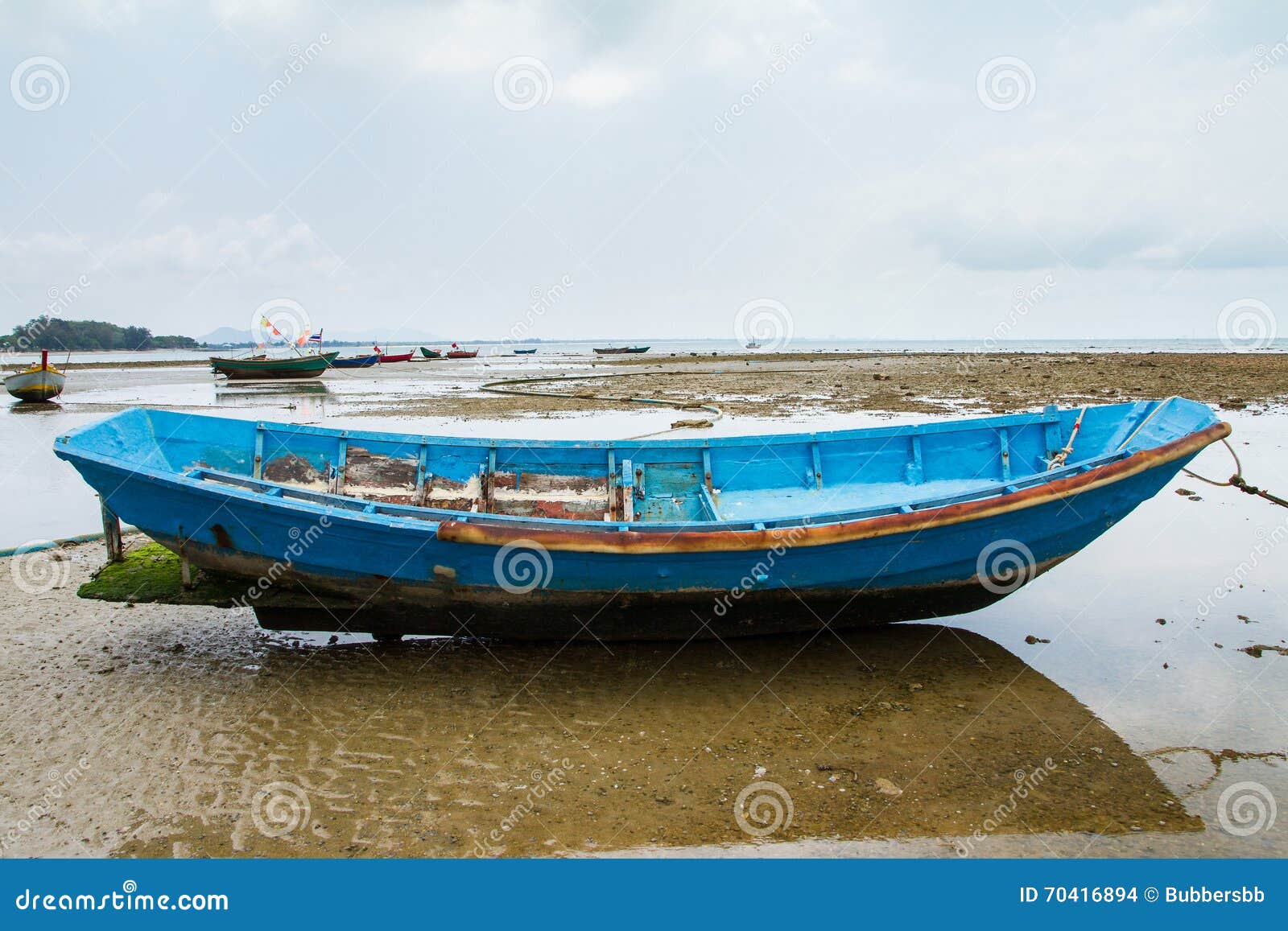 An Old Fishing Boat Moored Beached on the Beach at Low Tide. Stock ...