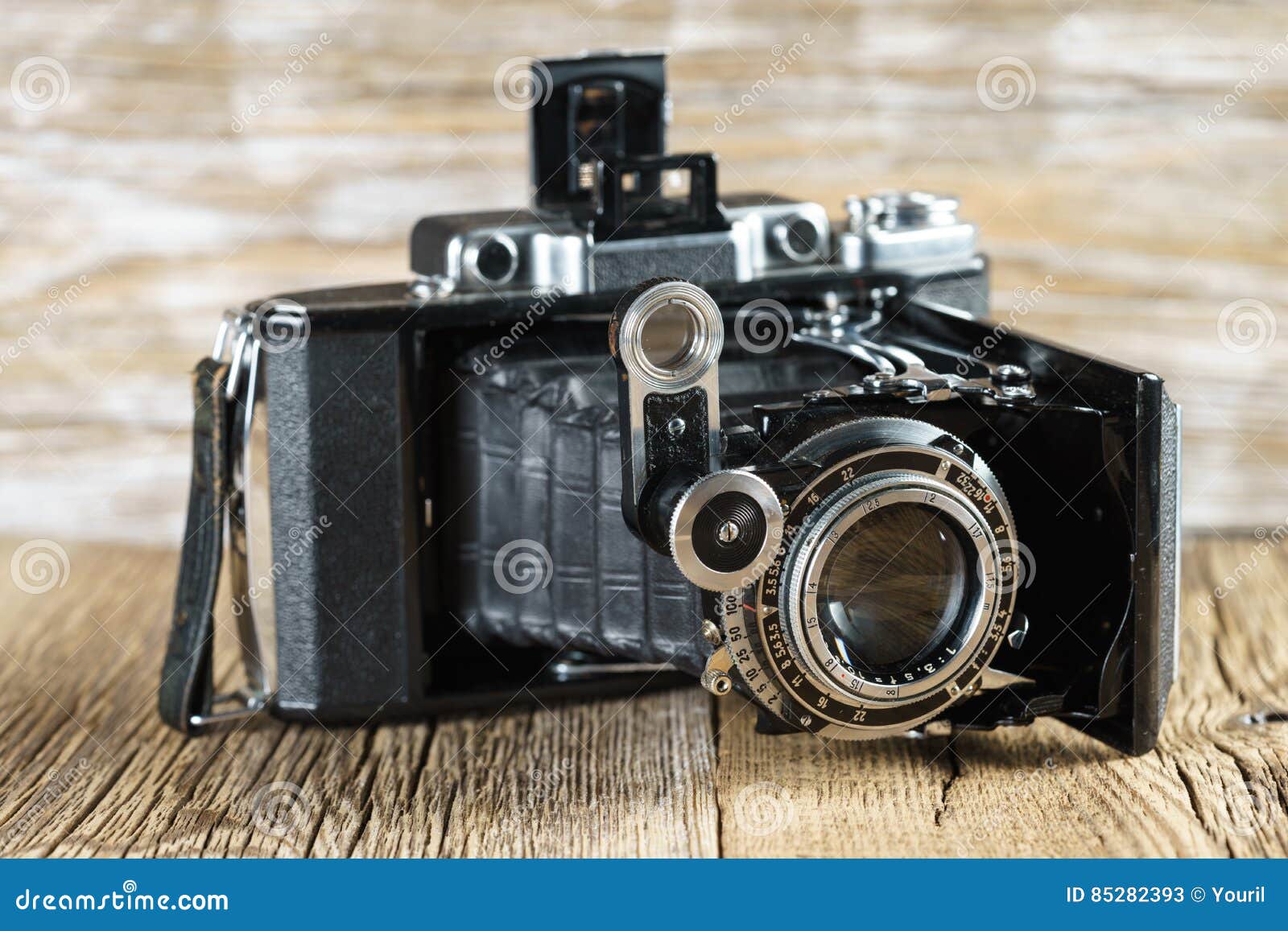 Old Folding Camera on a Textured Rustic Wooden Surface. Stock Image ...