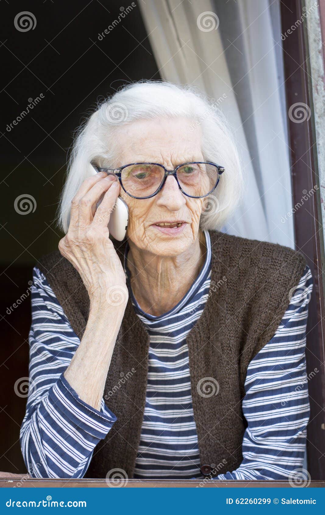 Old Grandma Talking on the Phone Standing on Her Window Stock Image ...