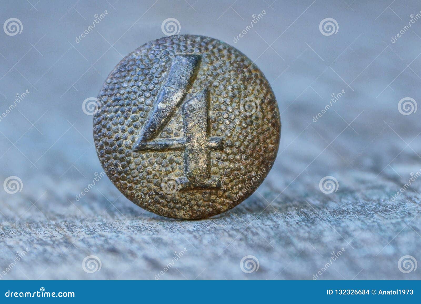 Old Gray Button with the Number Four on a Wooden Table Stock Photo ...