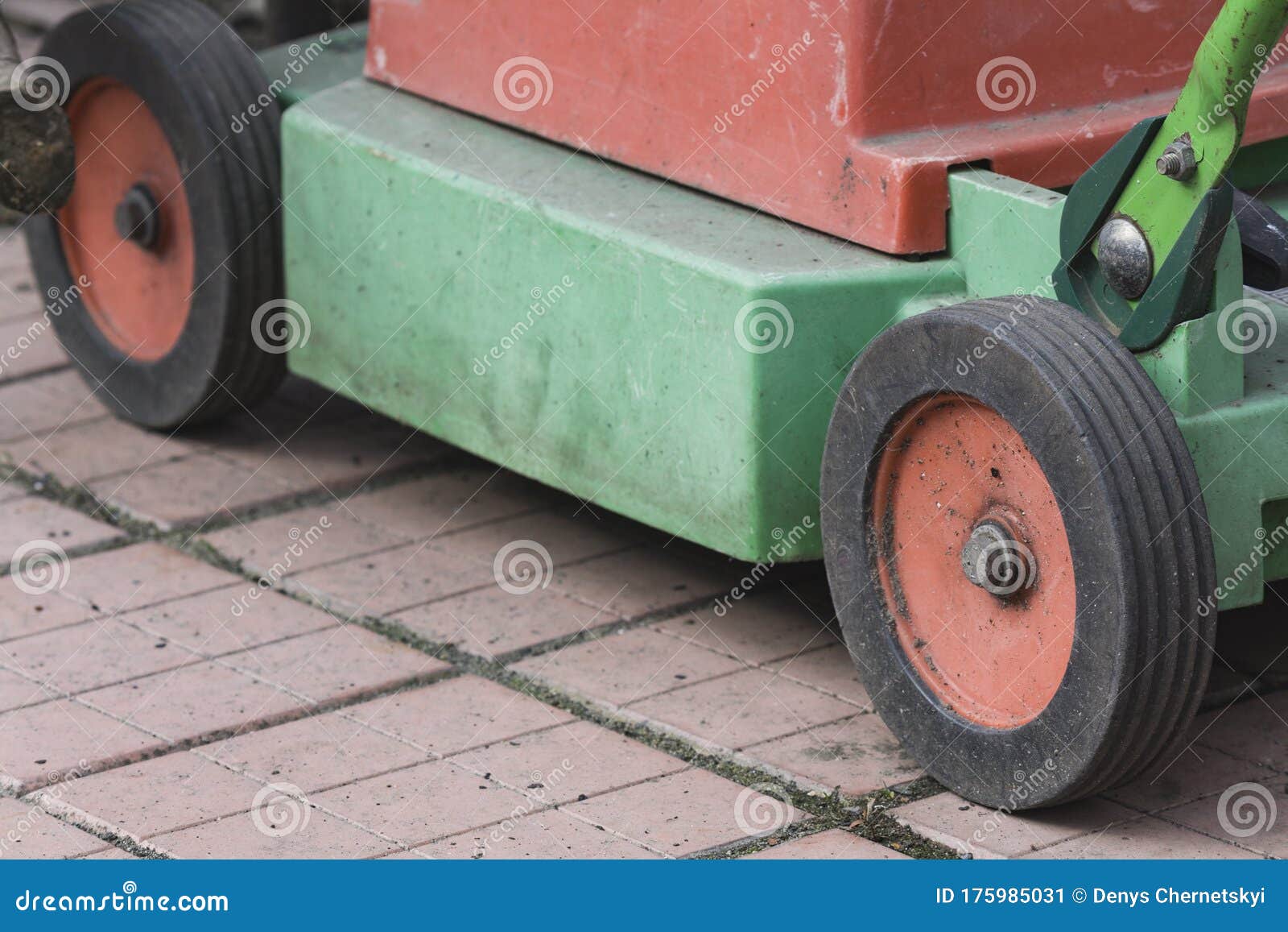 Old Green and Red Lawn Mower on a Brown Tile Stock Image - Image of ...