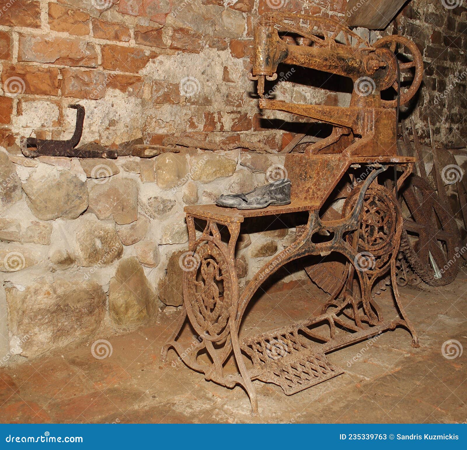 An Old, Historic, Rusty Sewing Machine on a Sewing Machine Table by a ...