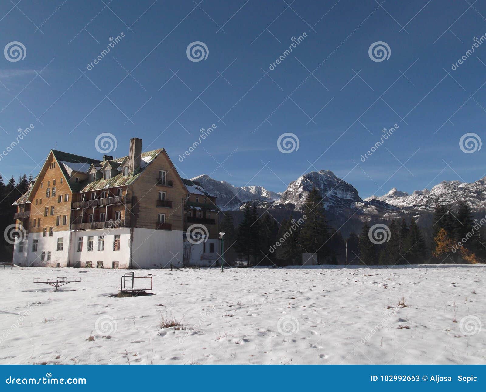 The Old,run-down,derelict,wooden Hotel And The Durmitor Mountain At The ...