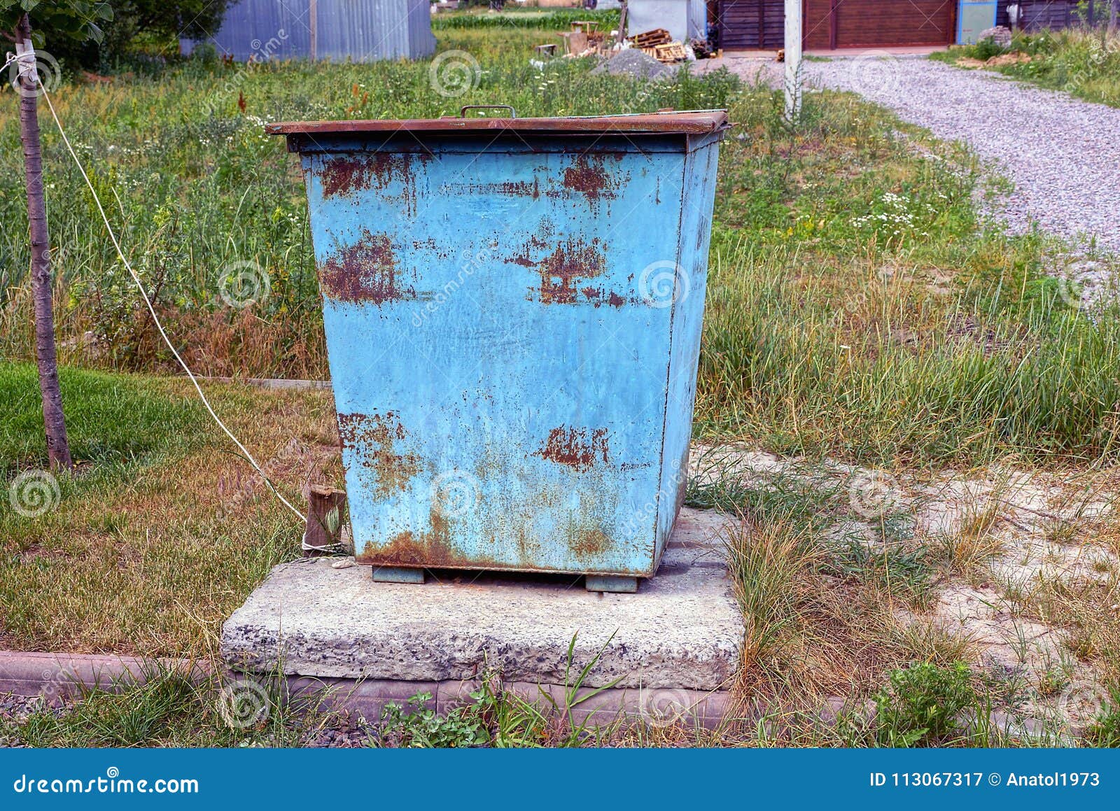 Old Iron Trash Can Outdoors in Grass Stock Image - Image of outdoors ...