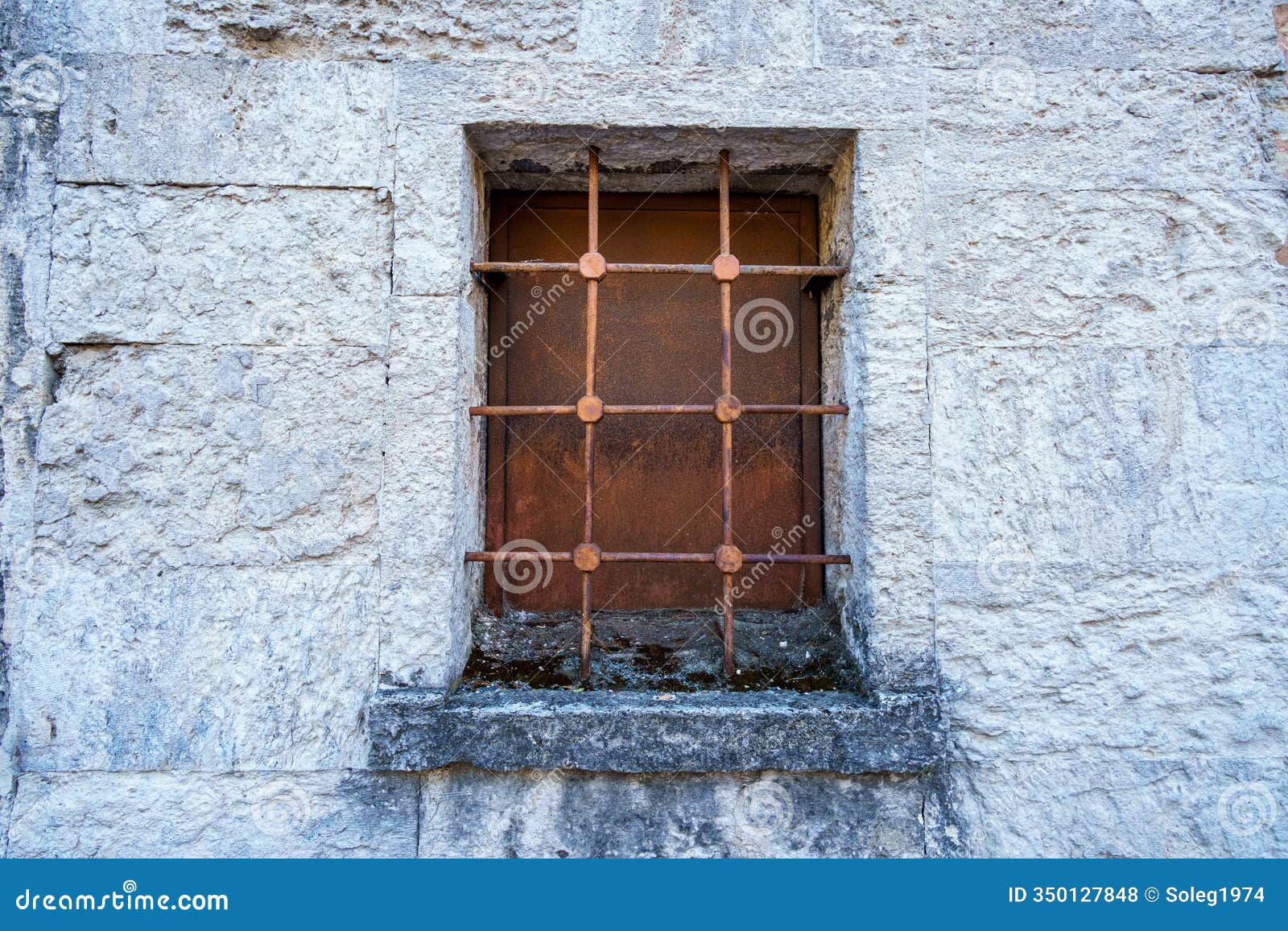 An Old Iron Window with Bars, Rusty, and a White Stone Wall Stock Photo ...