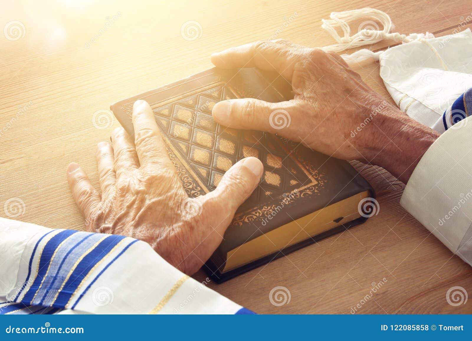 Old Jewish Man Hands Holding a Prayer Book, Praying, Next To Tallit ... Old Jewish Man Hands Holding a Prayer Book, Praying, Next To Tallit ...
