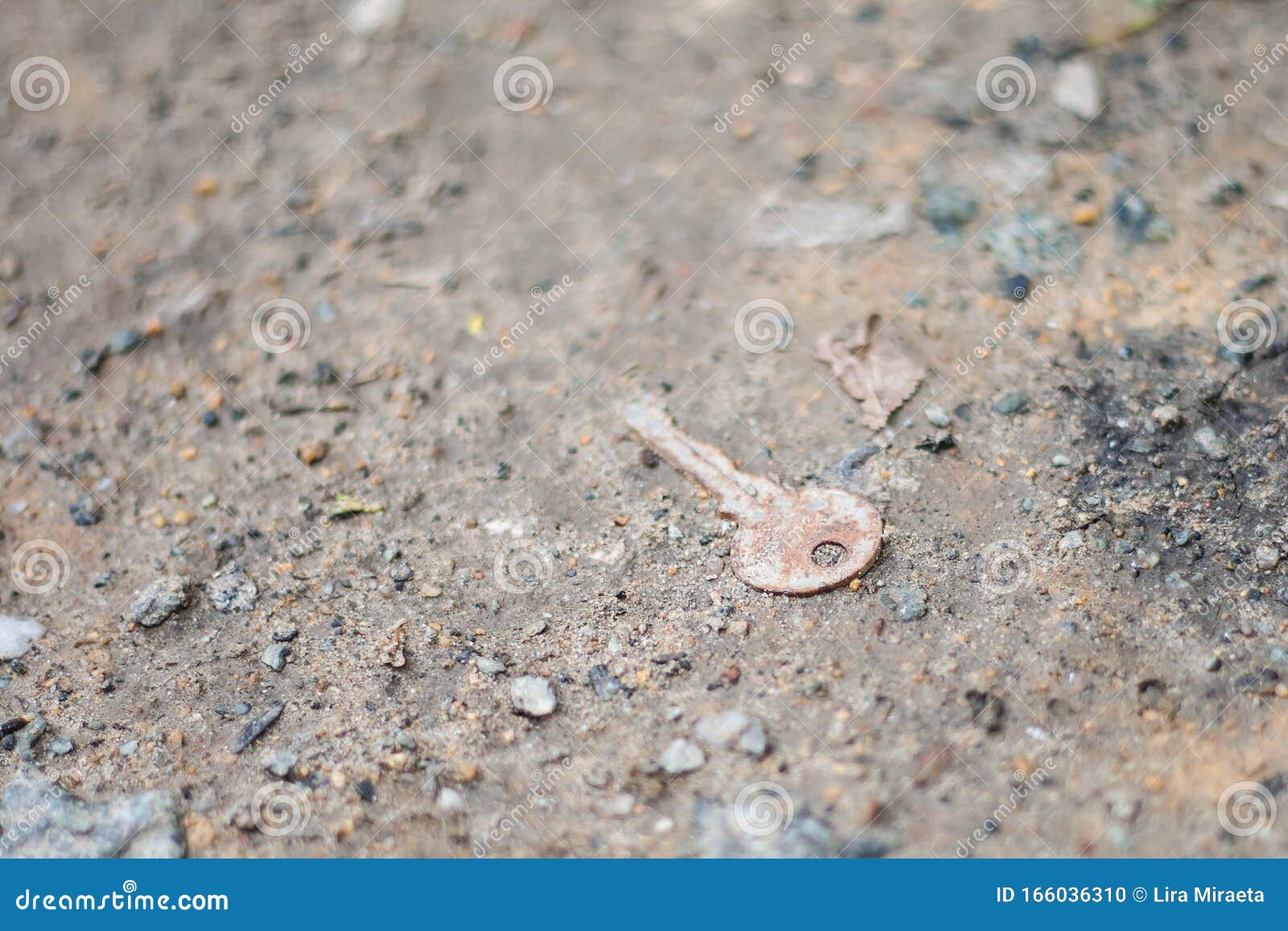 Old key lies on the ground stock photo. Image of pebbles - 166036310