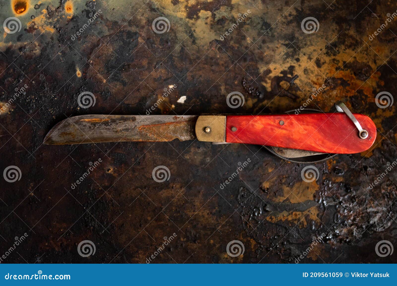 An Old Knife Covered in Rust. Knife with a Red Plastic Handle Stock ...