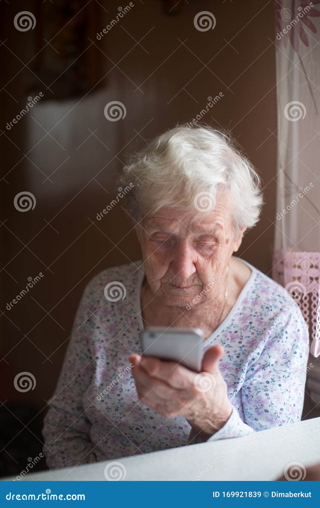 An Old Lady Pensioner Sits with a Smartphone in Her Hands Stock Image ...