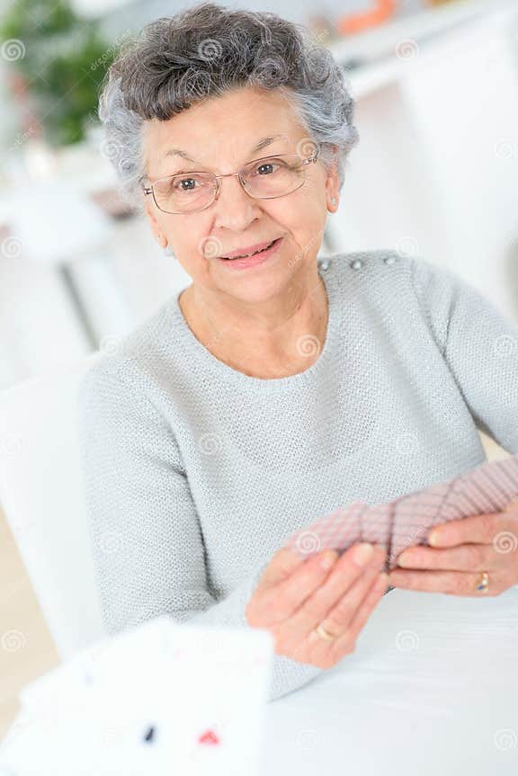 Old lady playing cards stock photo. Image of people - 261512128