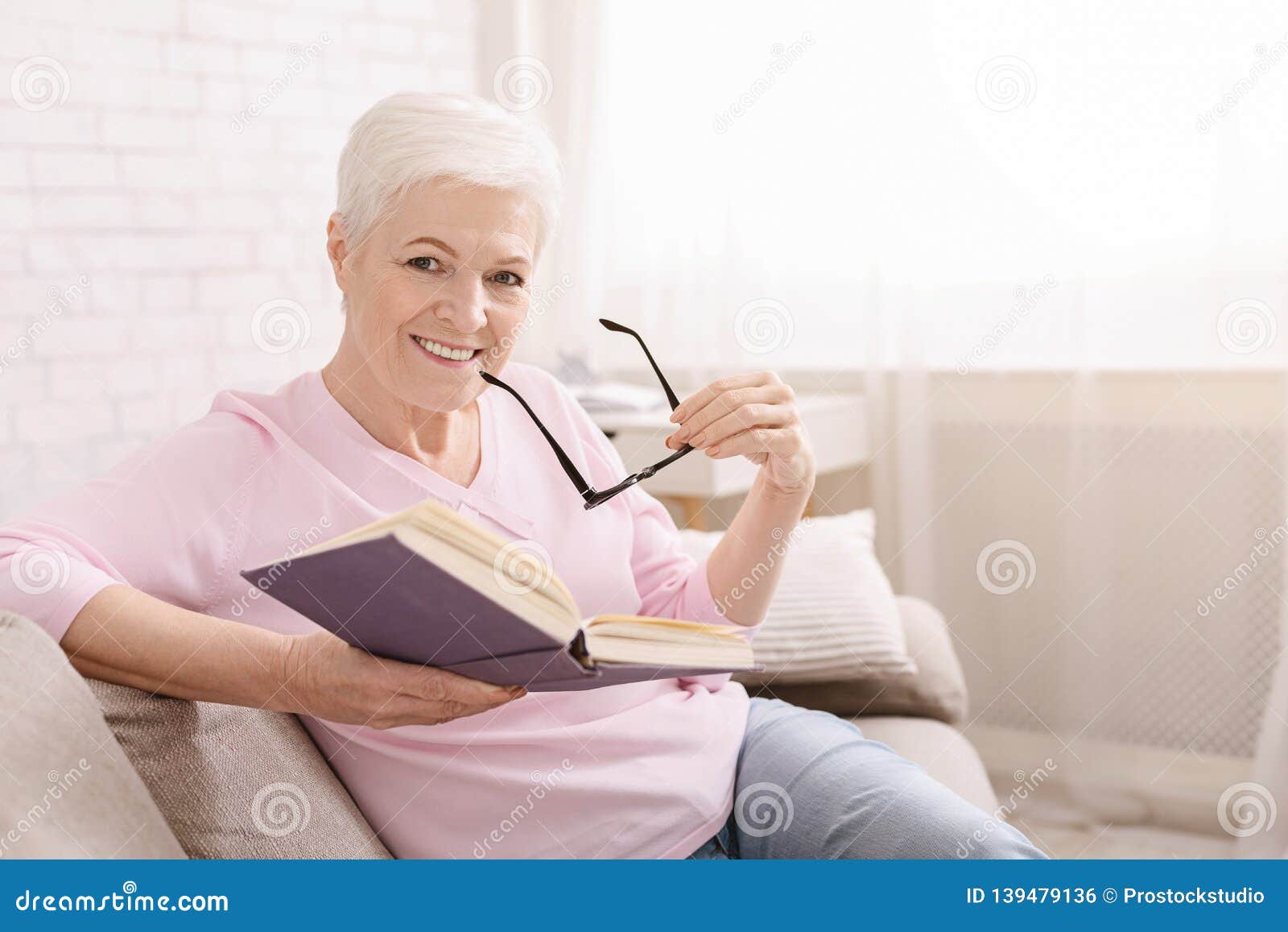 Old Lady Reading Book on Sofa at Home Stock Photo - Image of grandma ...