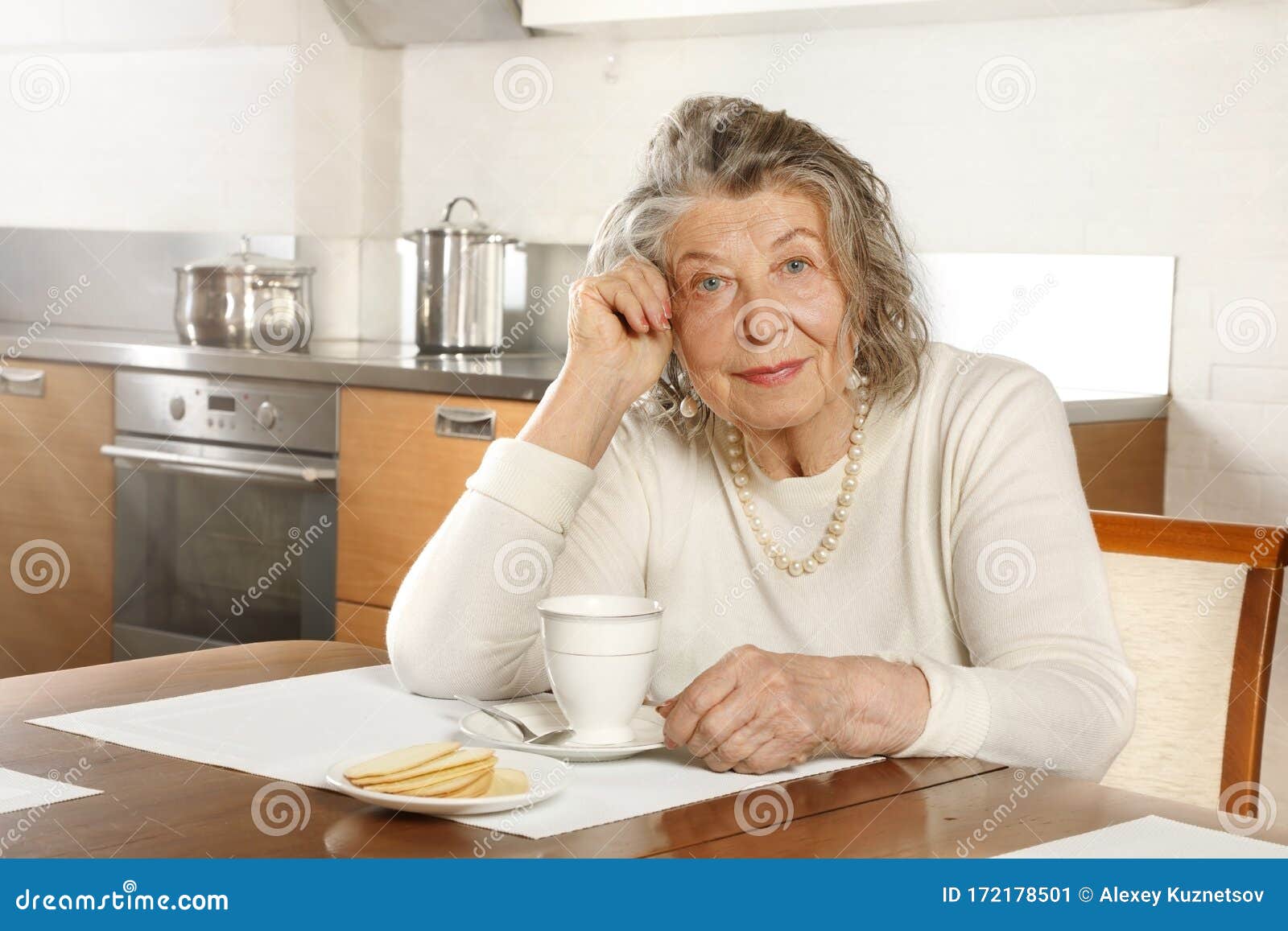 An Old Lady Sitting at the Kitchen Table Stock Image - Image of calm ...