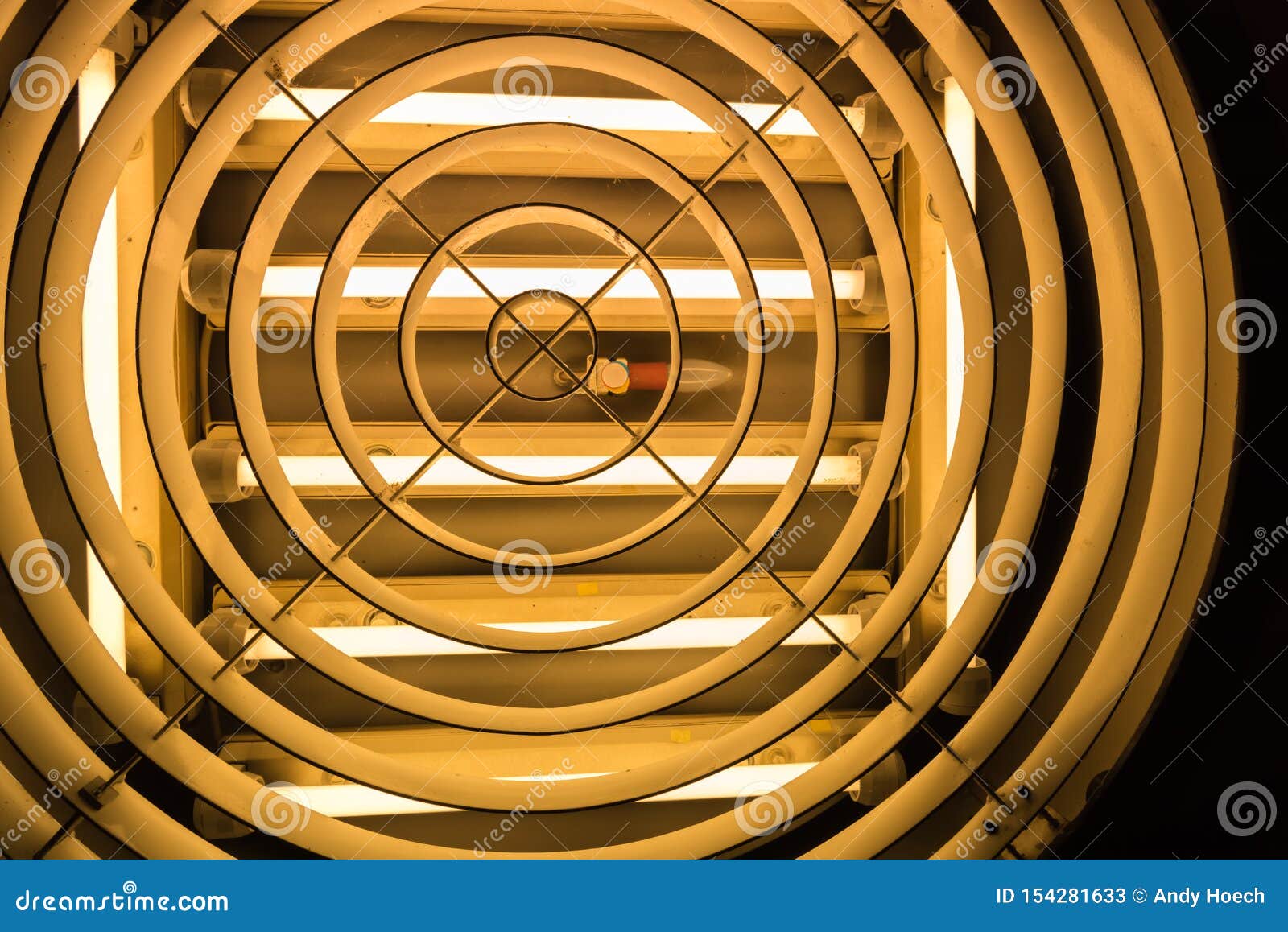 An Old Light Bulb in the Middle of Fluorescent Tubes Stock Image ...