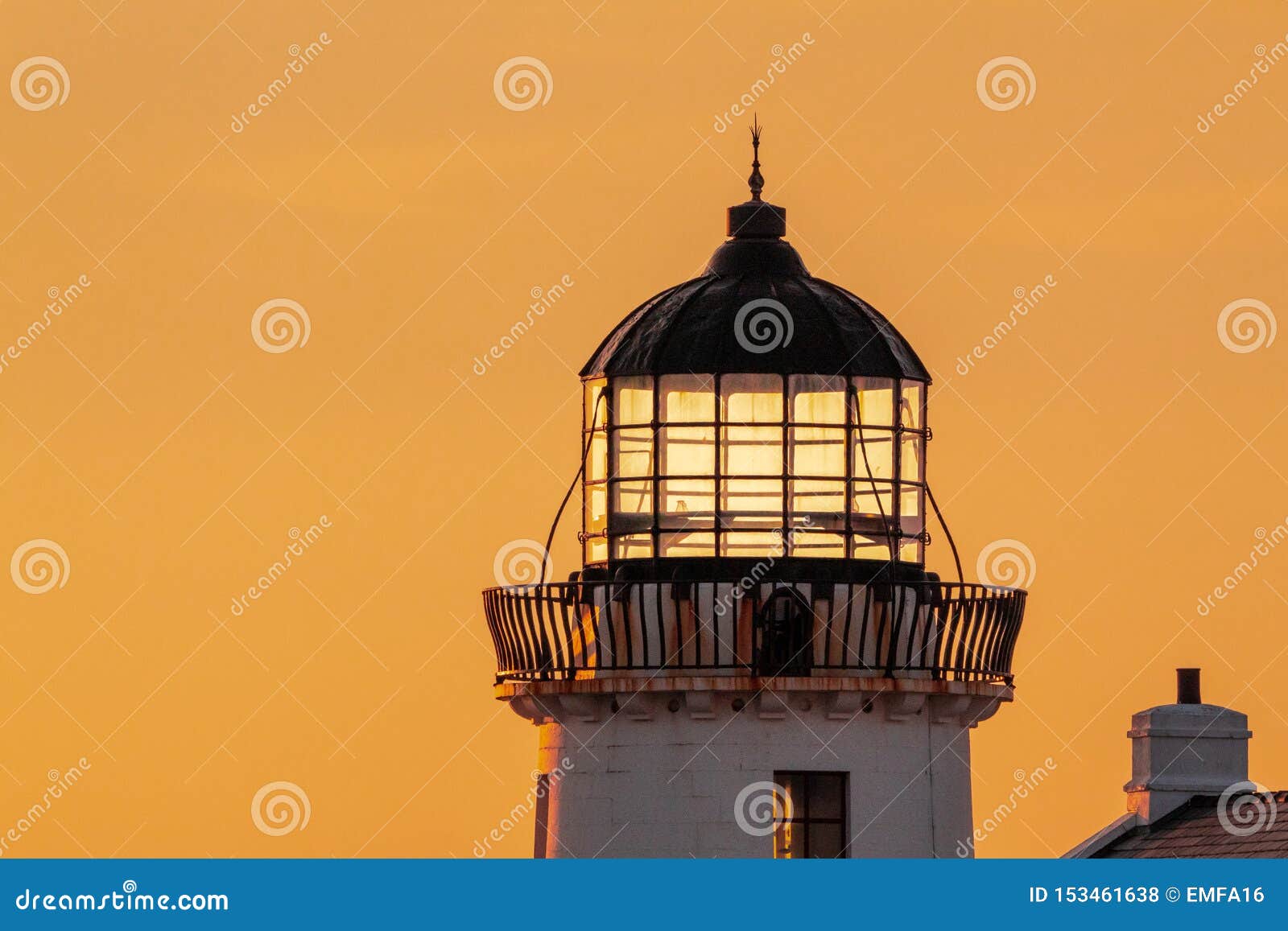 An Old Lighthouse Beacon Lighting Up at a Golden Sunset Stock Photo ...