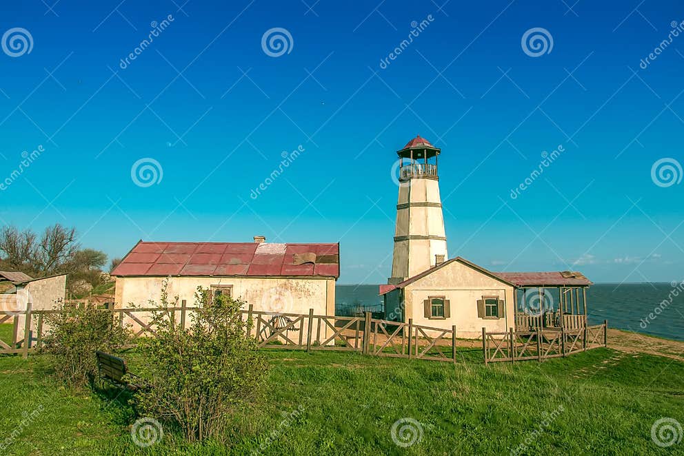 Old Lighthouse and Houses on the Beach Stock Photo - Image of nature ...