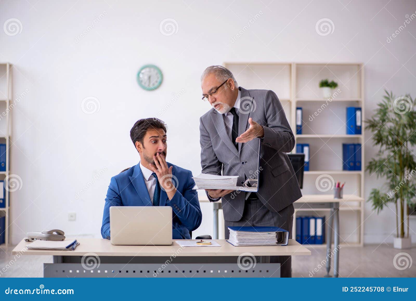 Old Male Boss and Young Male Employee Working in the Office Stock Photo ...