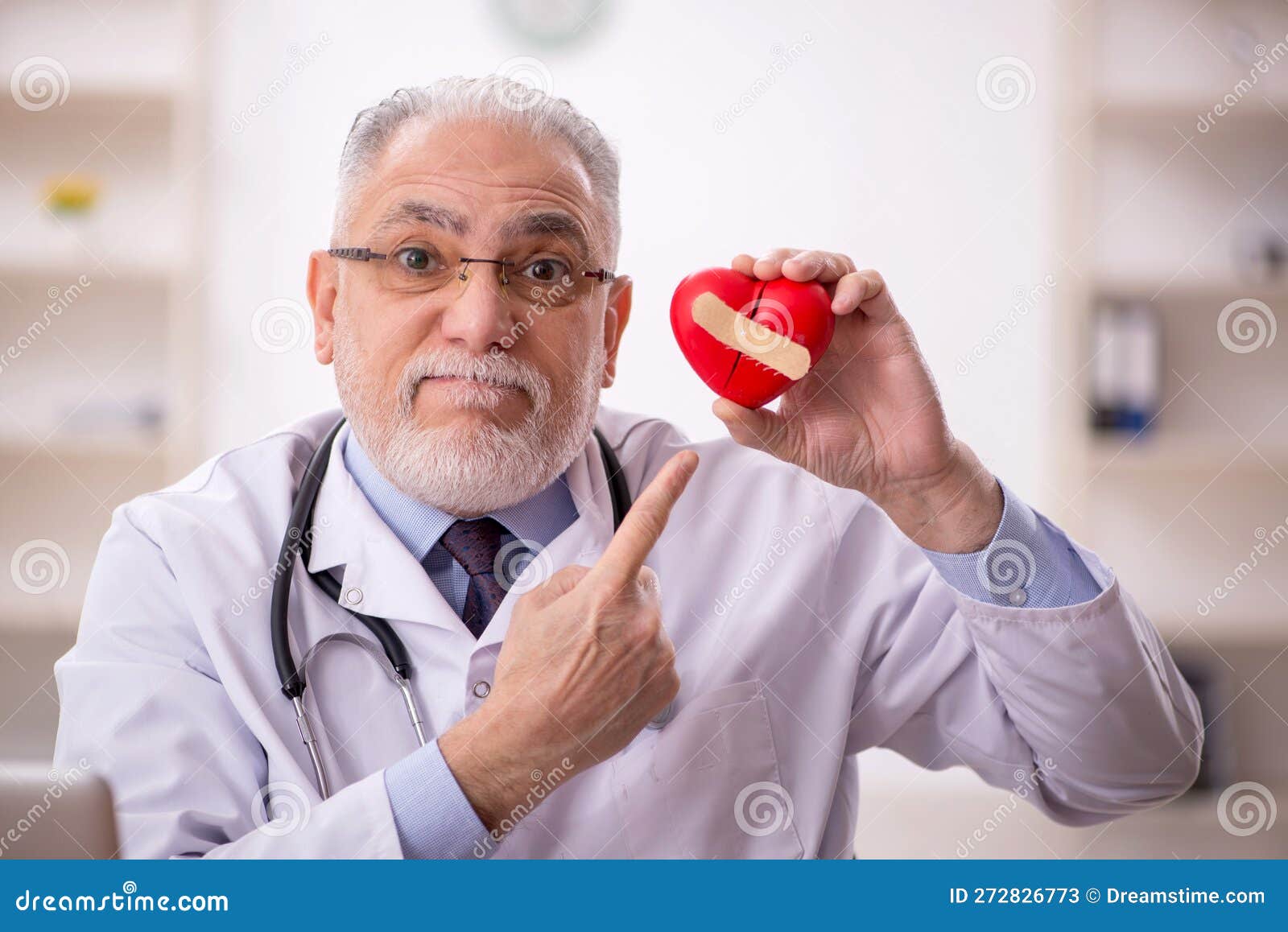Old Male Cardiologist Holding Heart Model Stock Image - Image of ...